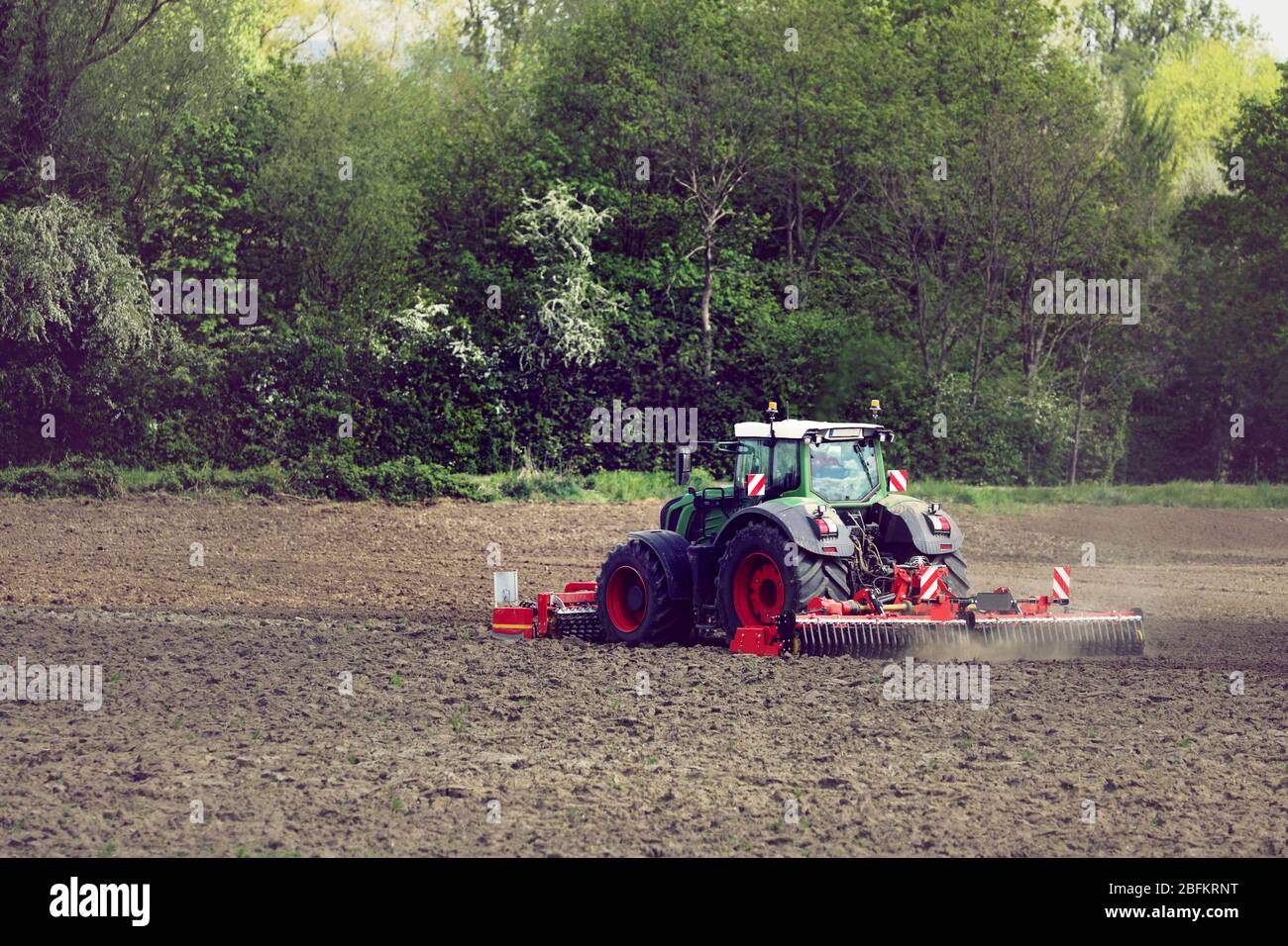 Farmer with his tractor on the field Stock Photo - Alamy