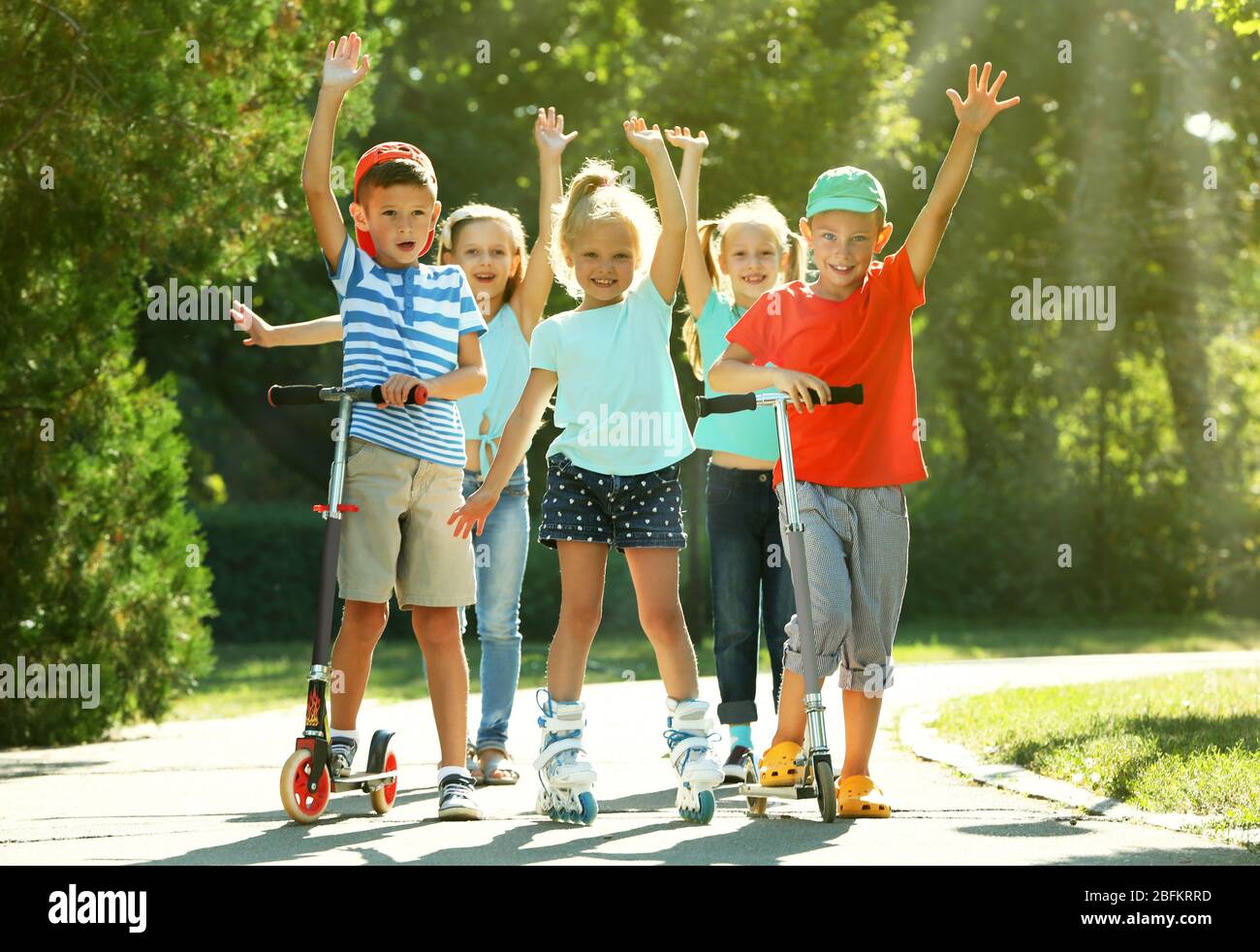Children riding their scooters hi-res stock photography and images - Alamy