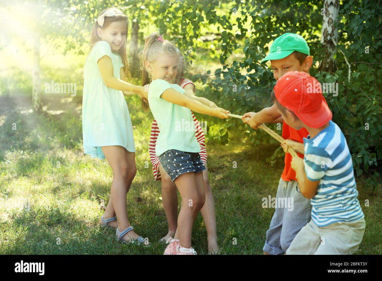 Happy active children playing in park Stock Photo - Alamy