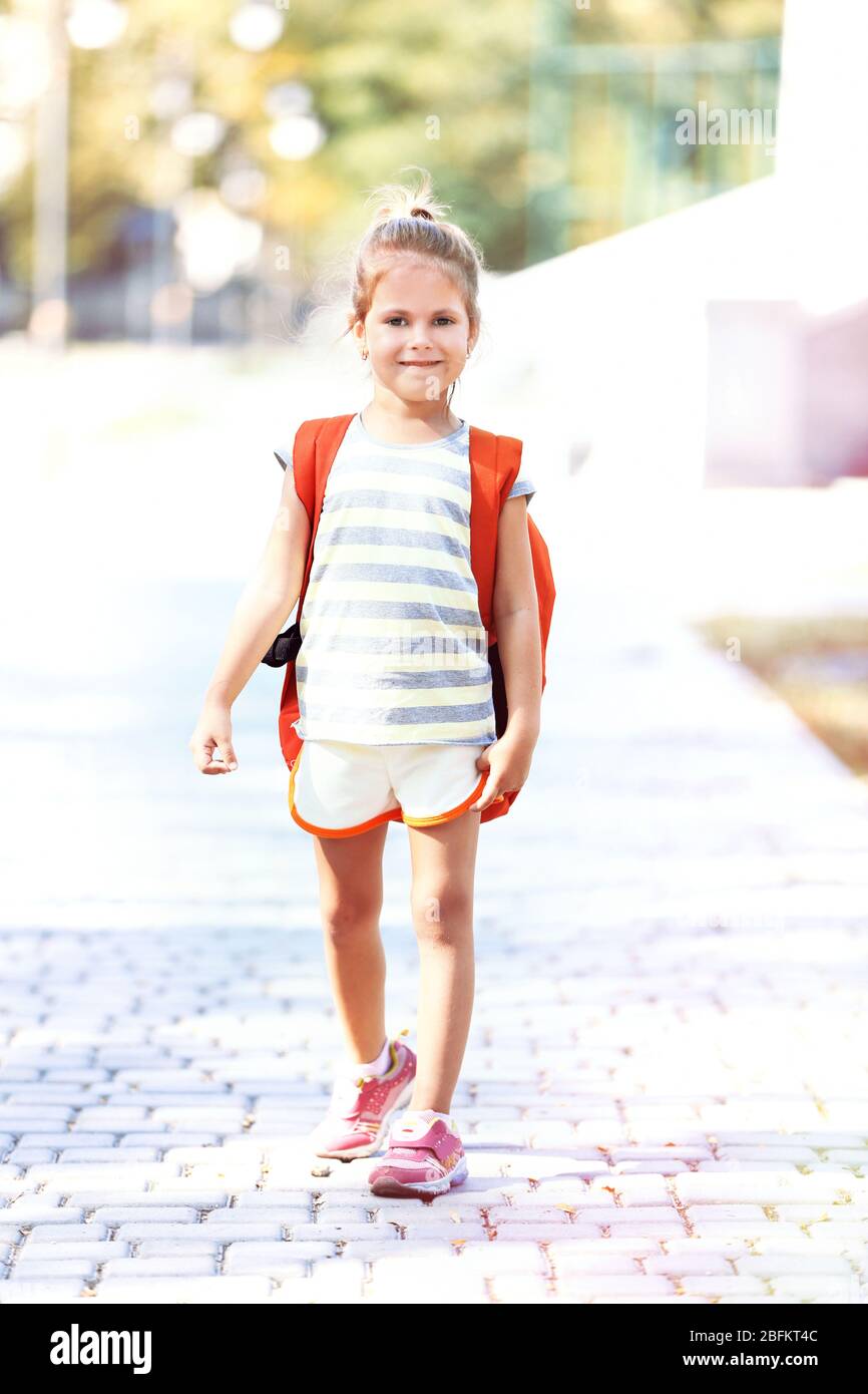 Little girl with large school bag, outdoor Stock Photo - Alamy