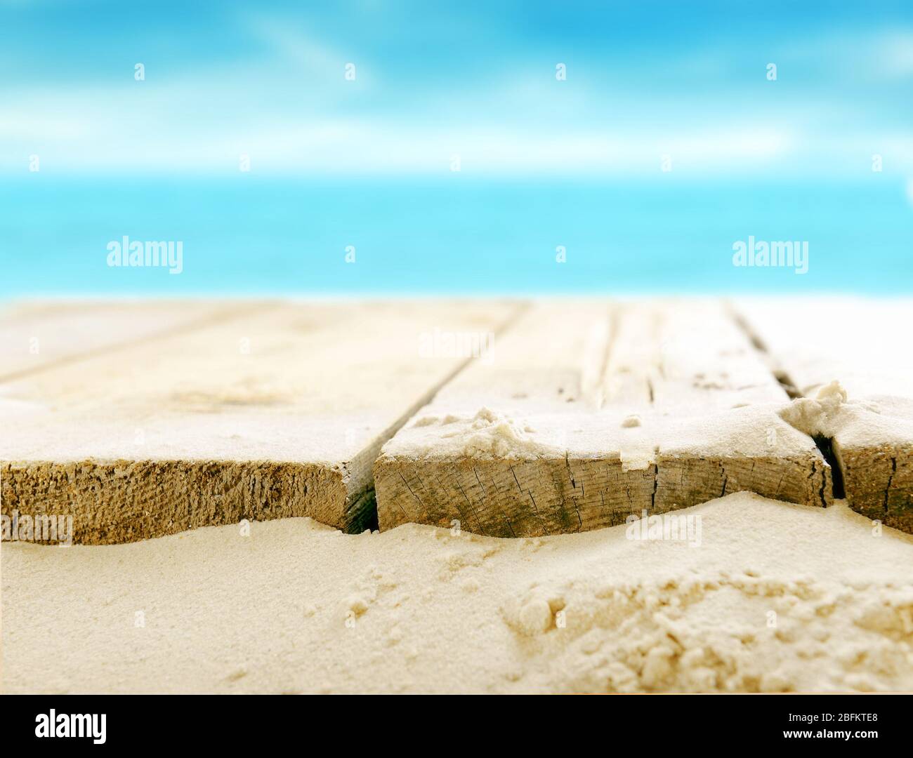 Sand with wooden planks on sea background Stock Photo - Alamy