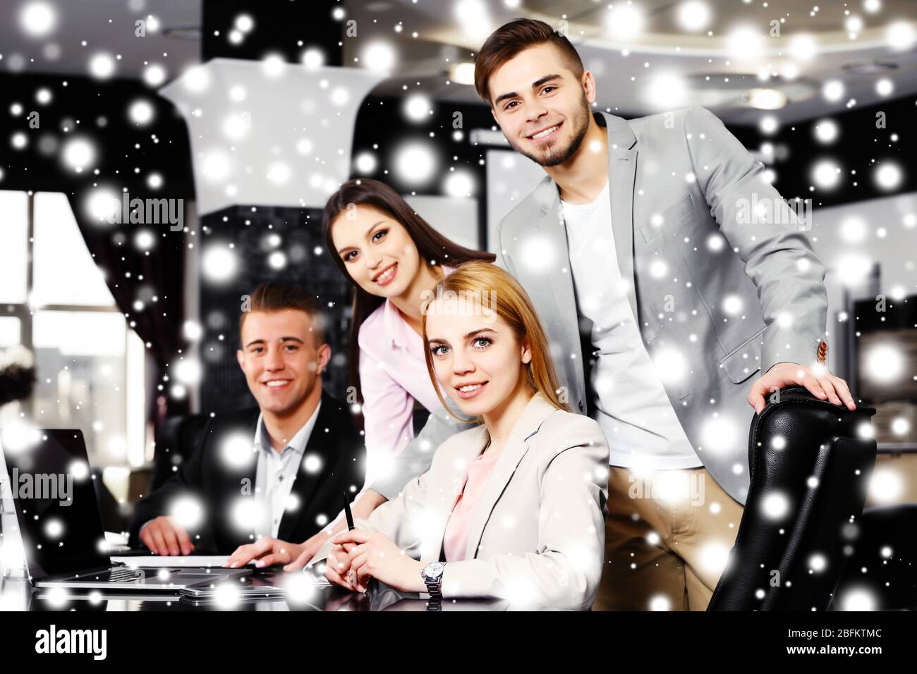 Business people working in office over snow effect Stock Photo - Alamy