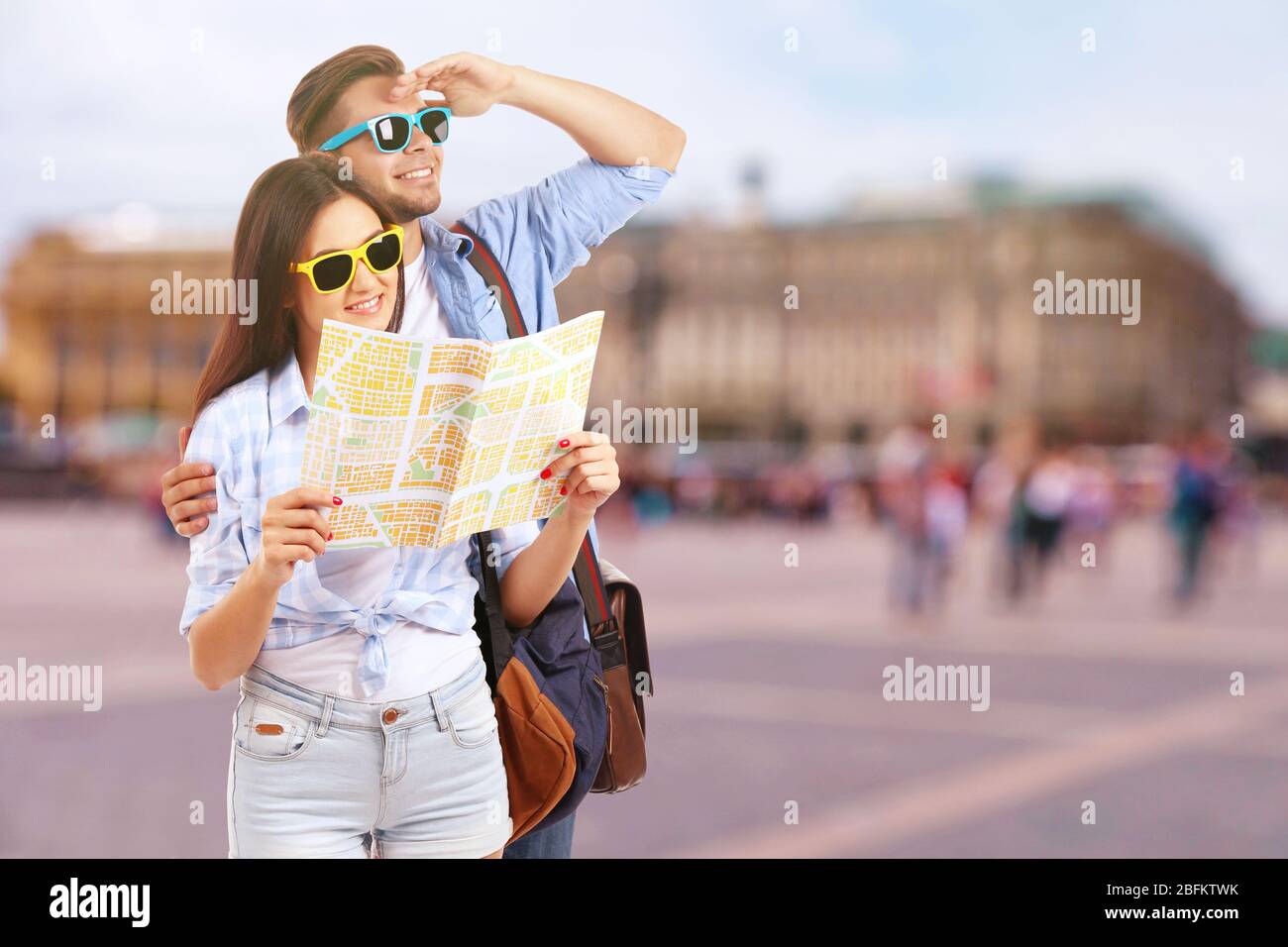 Happy tourists on street in city Stock Photo - Alamy