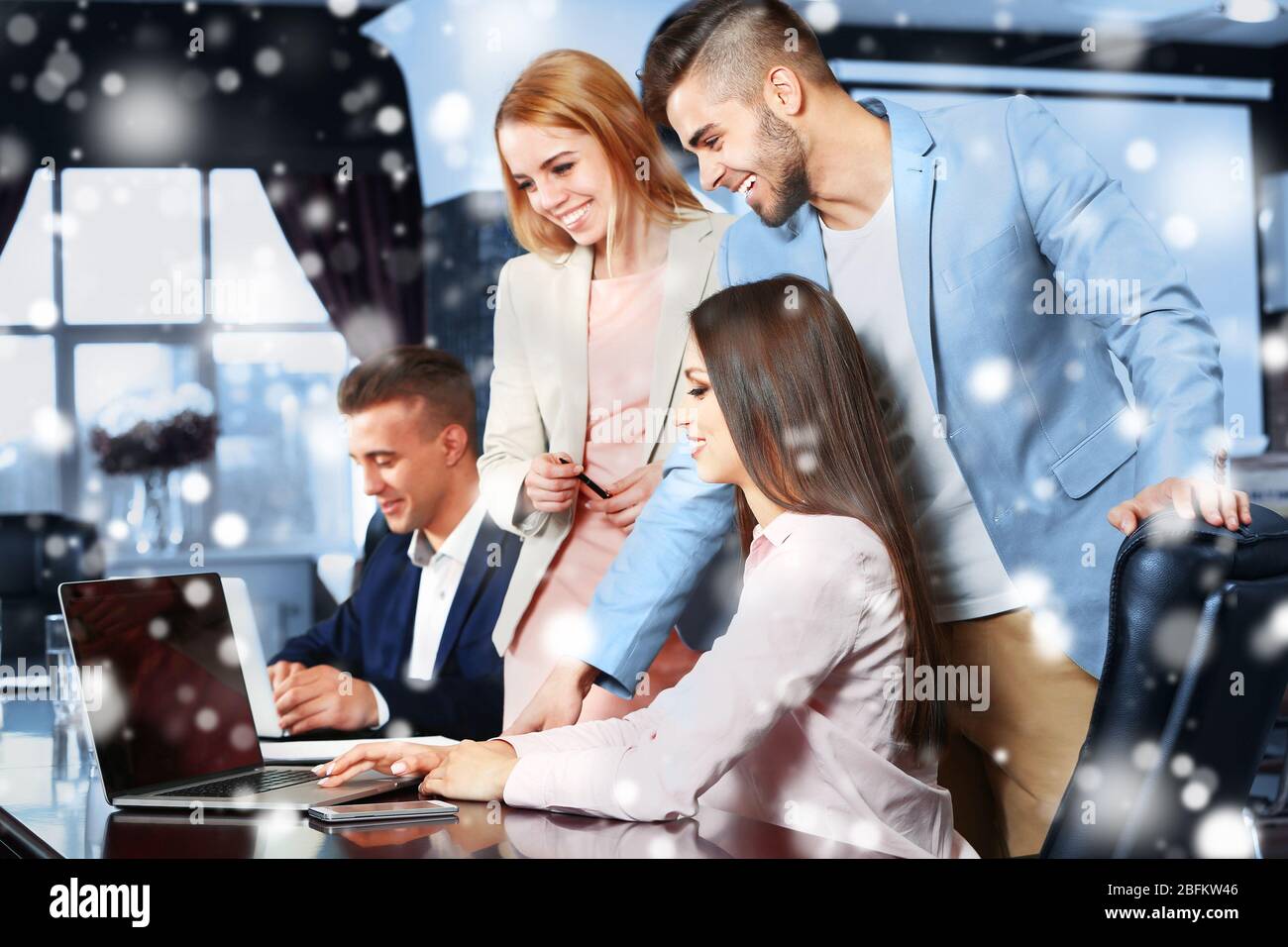 Business people working in office over snow effect Stock Photo - Alamy