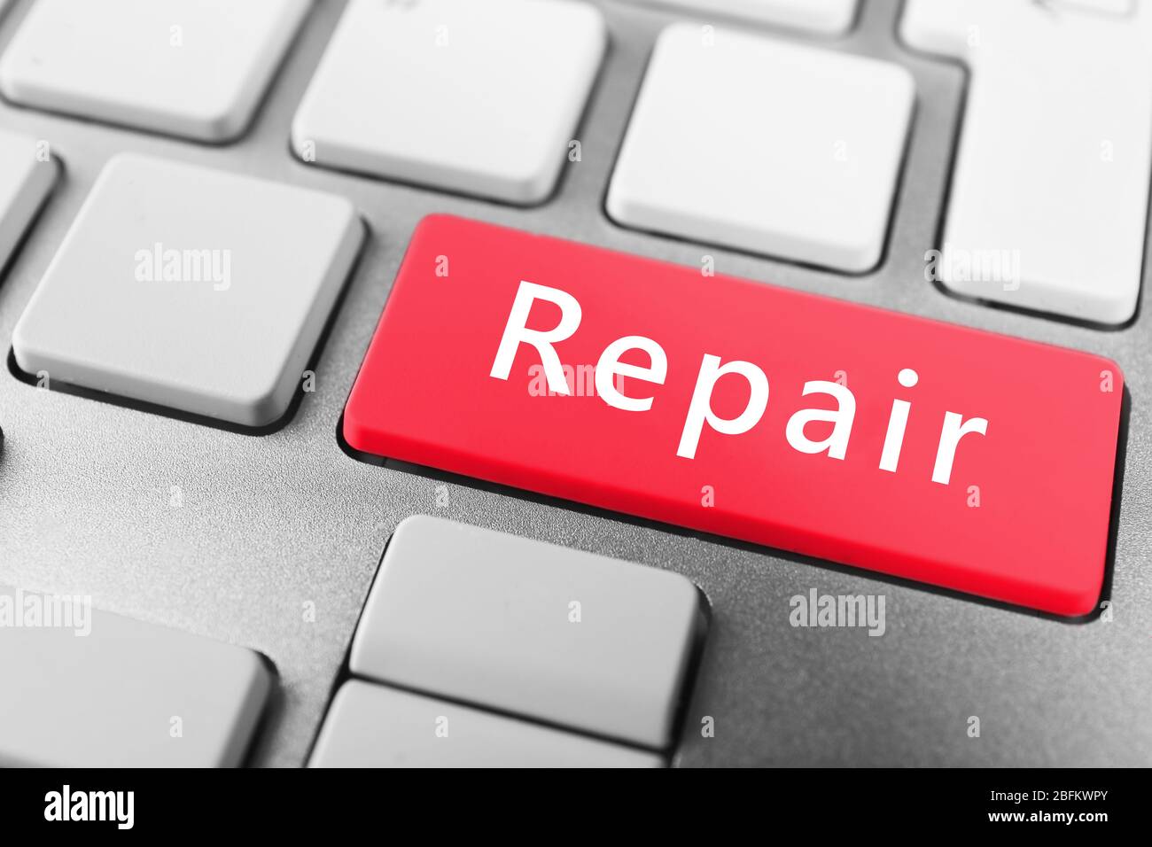 Close-up of laptop keyboard with color button and word Repair Stock ...