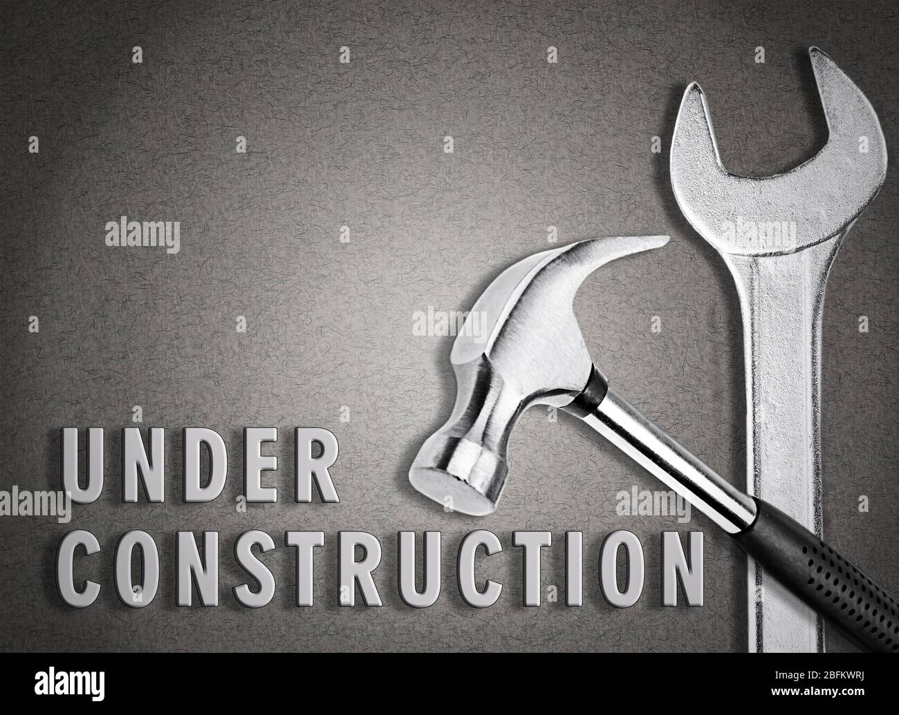 Text Under construction on grey textured background Stock Photo - Alamy