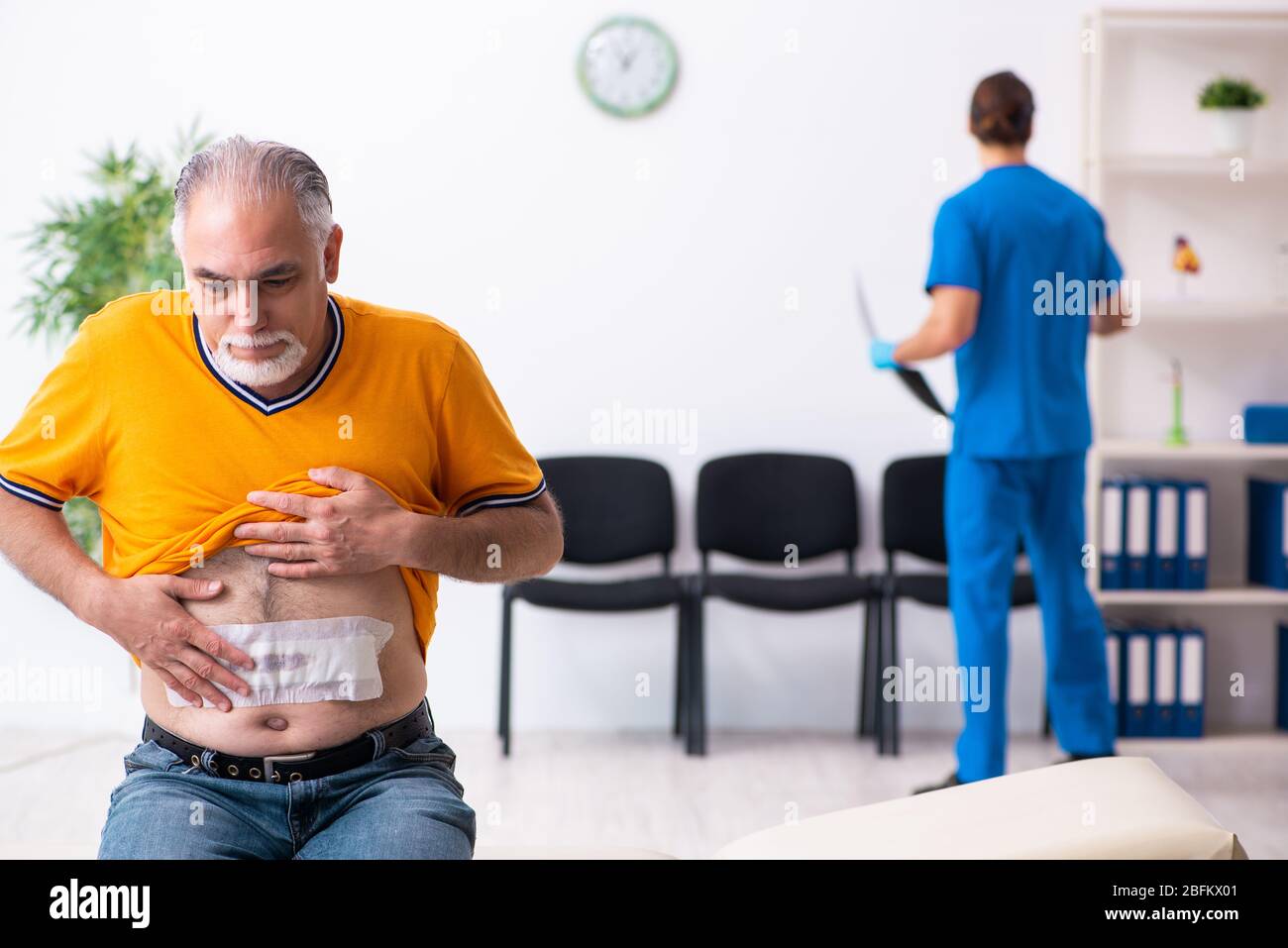 Old man visiting male doctor Stock Photo - Alamy