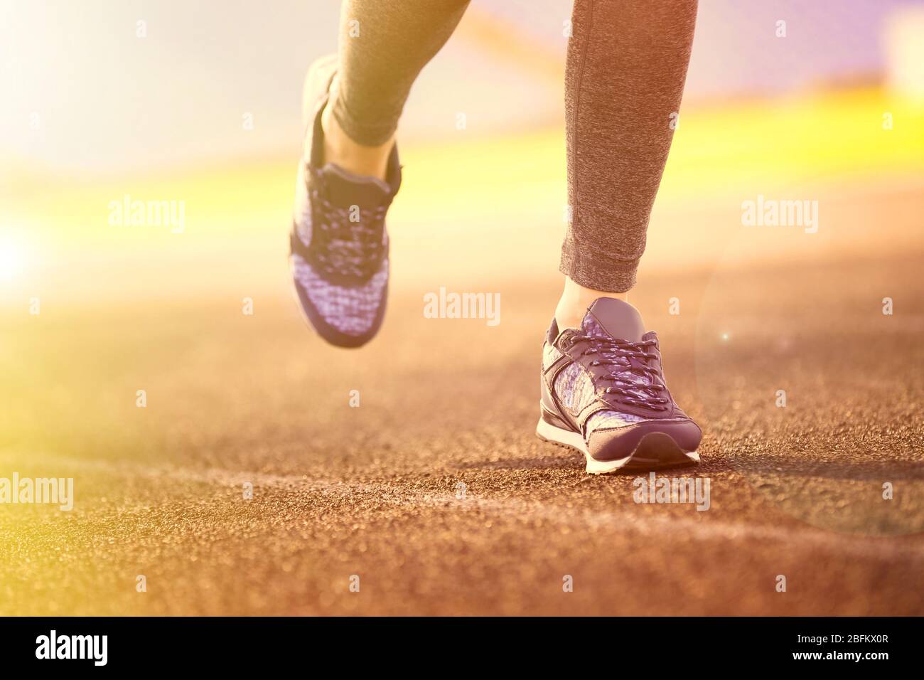 Sports woman legs in running movement Stock Photo - Alamy