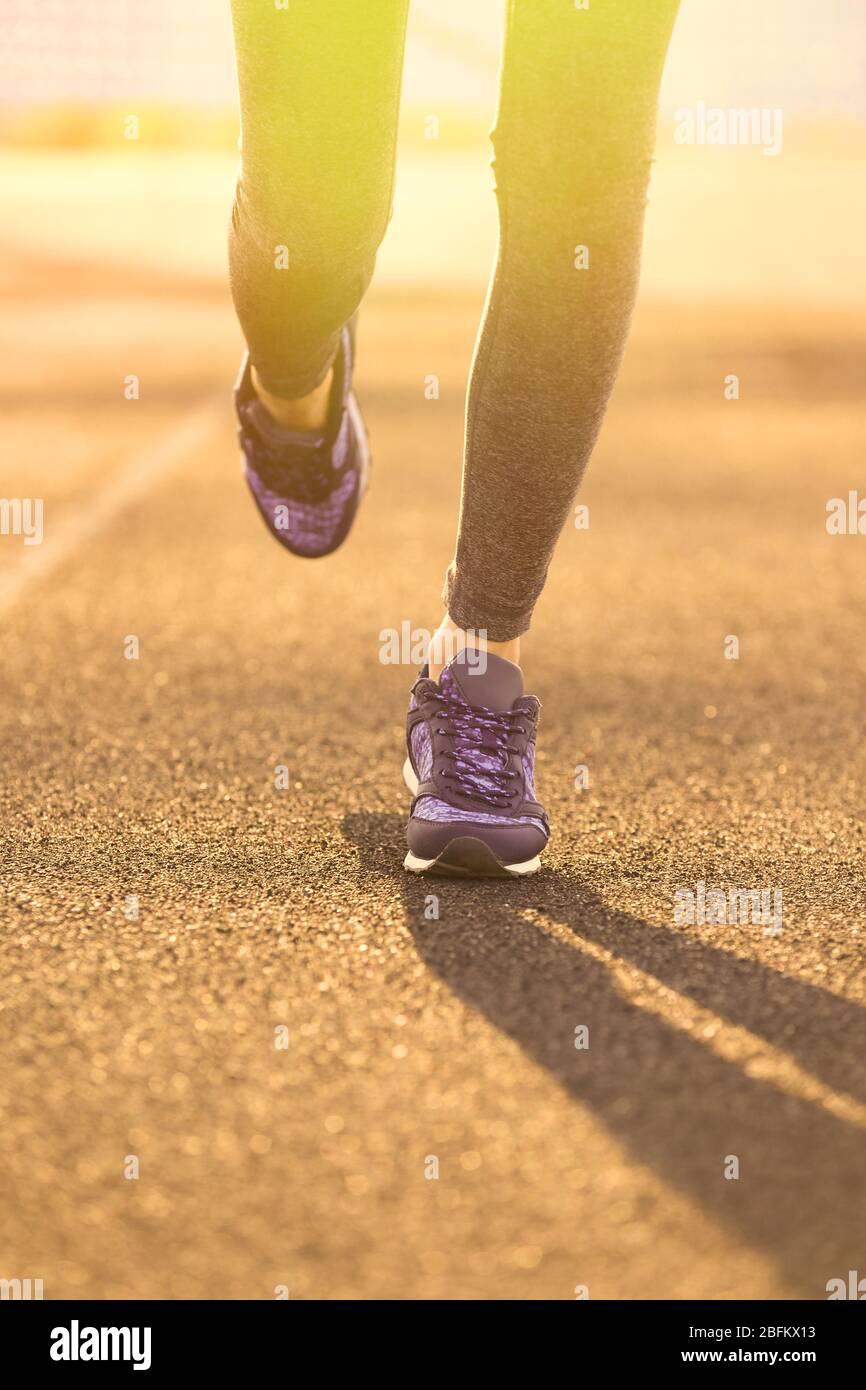 Sports woman legs in running movement Stock Photo - Alamy