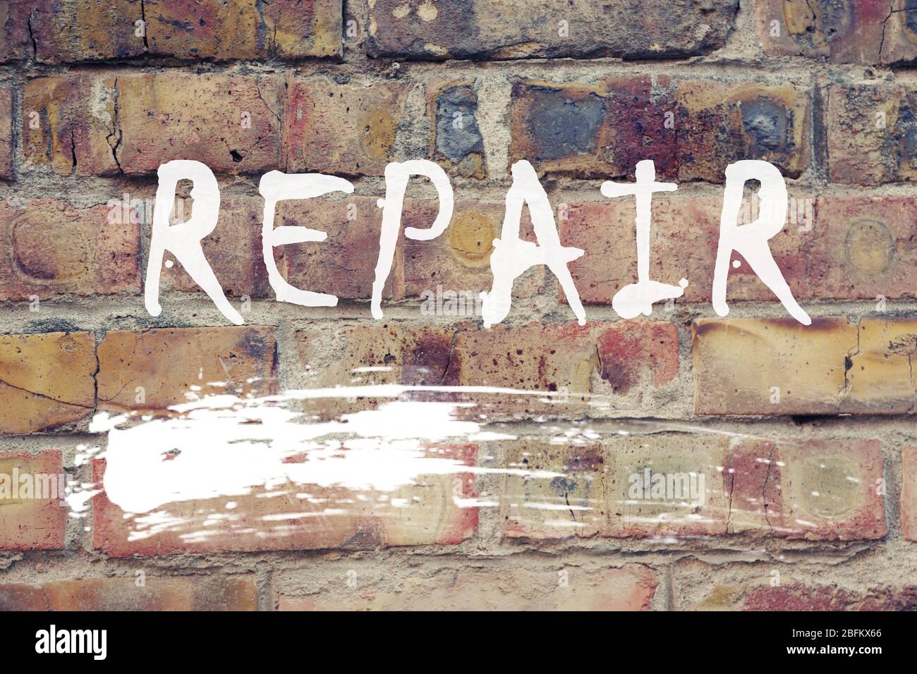 Word Repair made with white paint on brick wall background Stock Photo ...