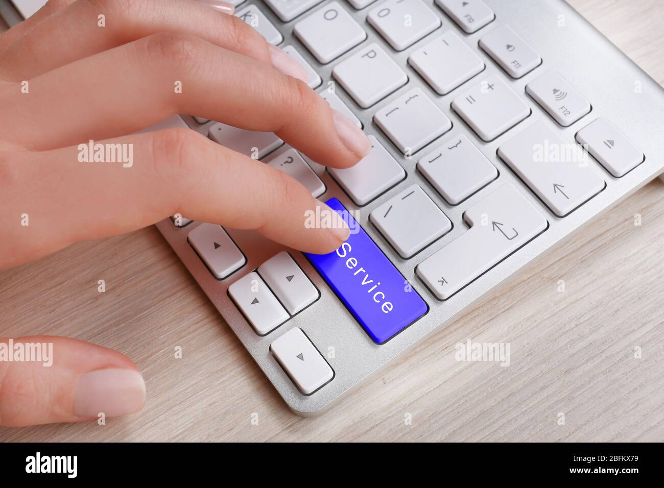 Close-up of laptop keyboard with color button and word Service Stock ...