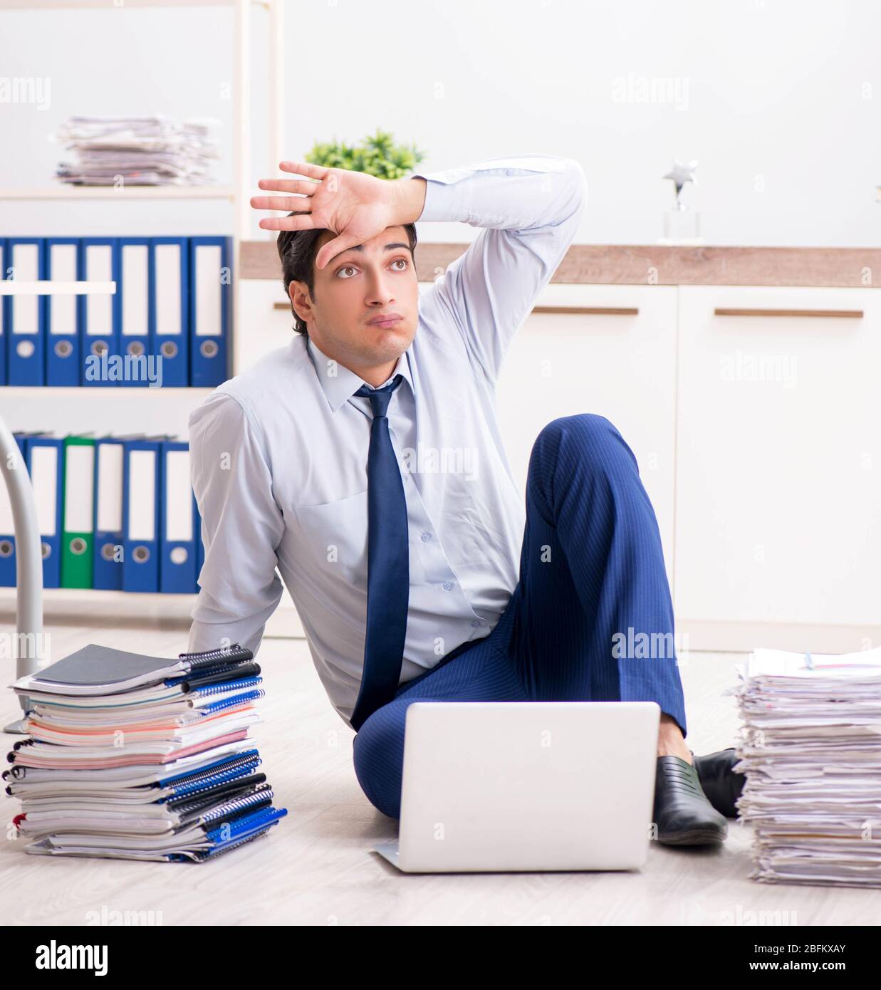 The extremely busy employee working in the office Stock Photo - Alamy
