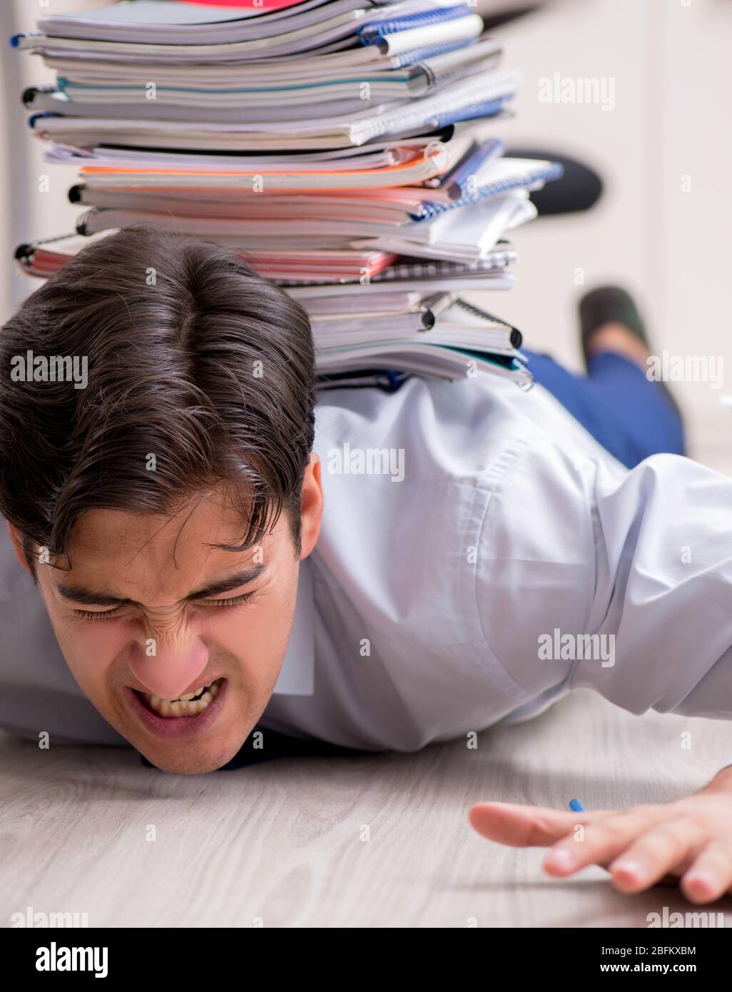 The extremely busy employee working in the office Stock Photo - Alamy