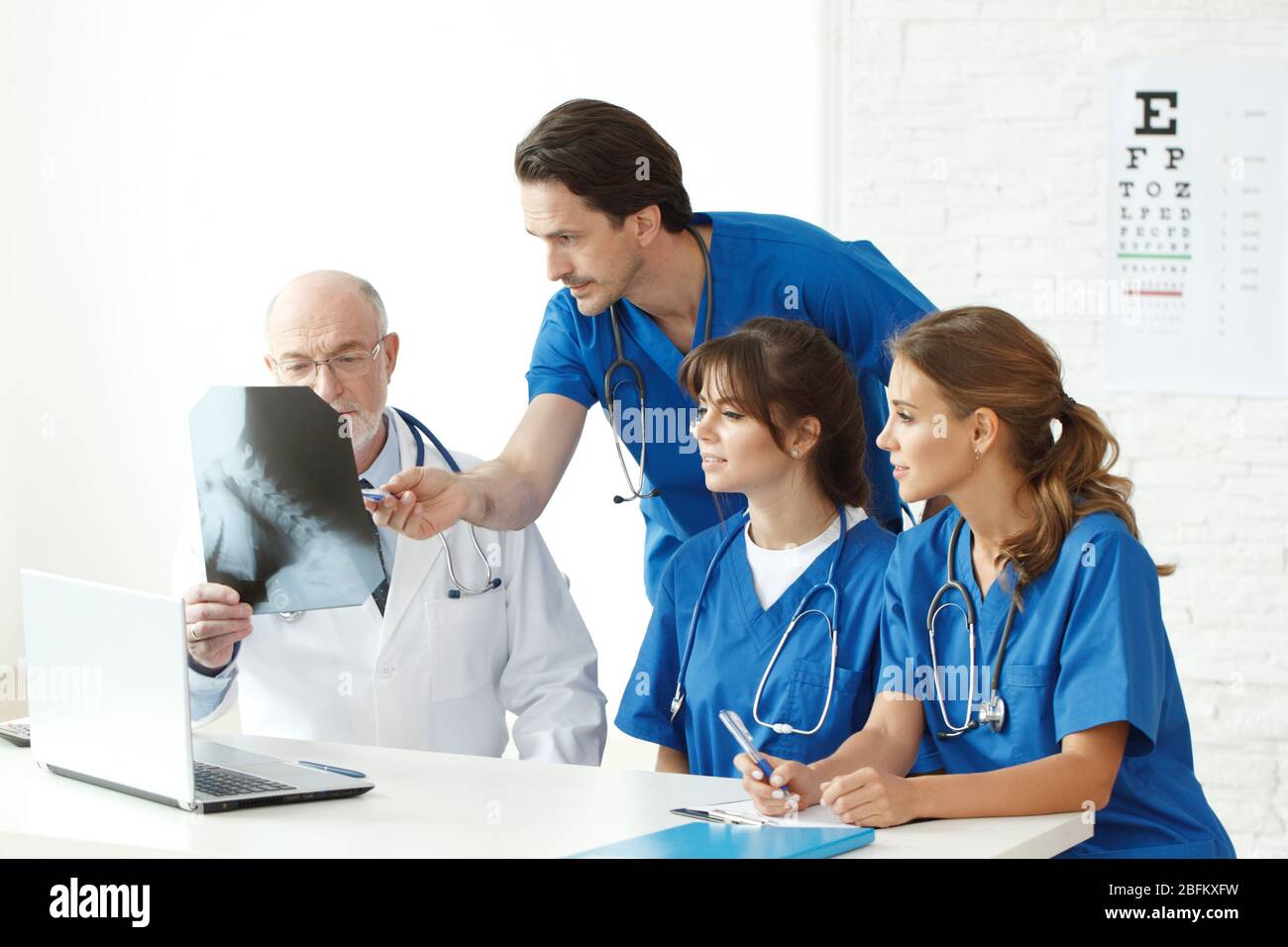 Medical team checking on X-ray results at clinical office Stock Photo ...