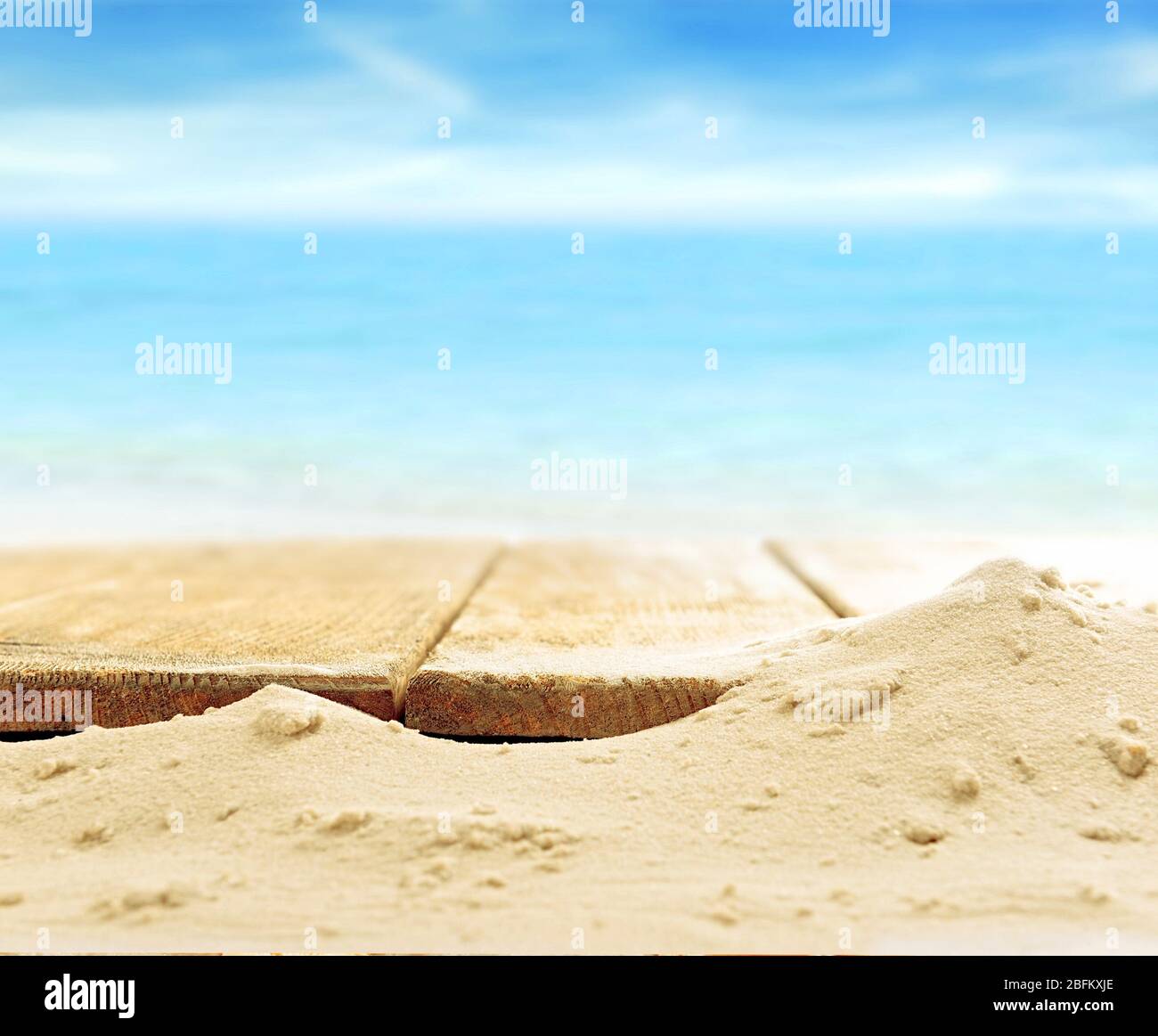 Sand with wooden planks on sea background Stock Photo - Alamy