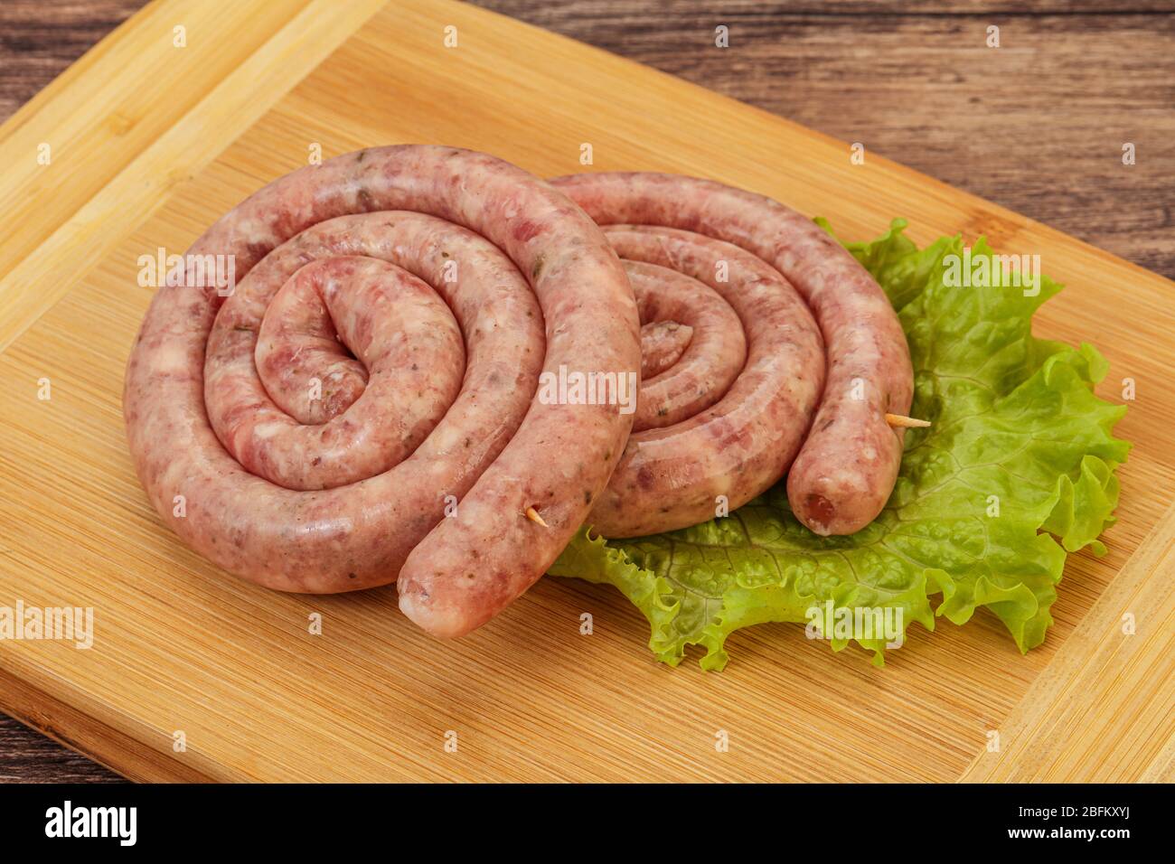 Raw pork sausage ring for grill Stock Photo - Alamy