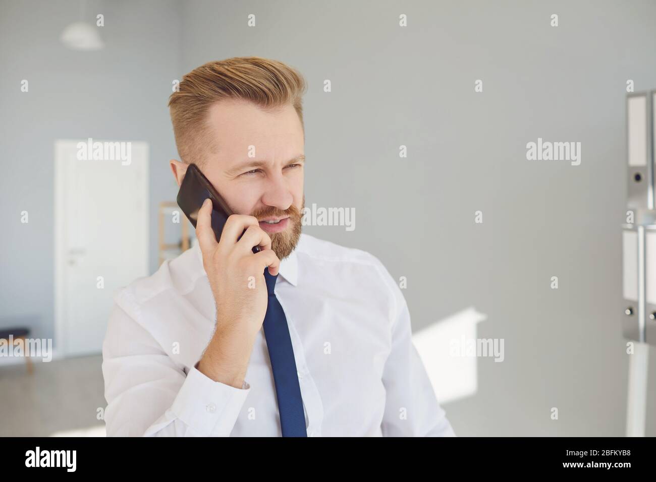 Confident adult businessman serious having phone conversation Stock ...