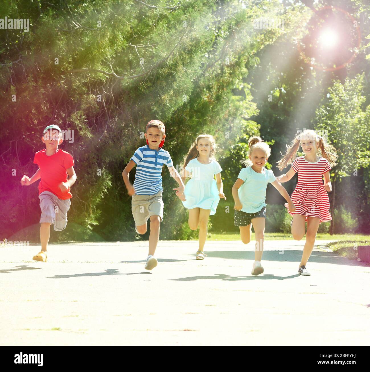Happy active children running in park Stock Photo - Alamy