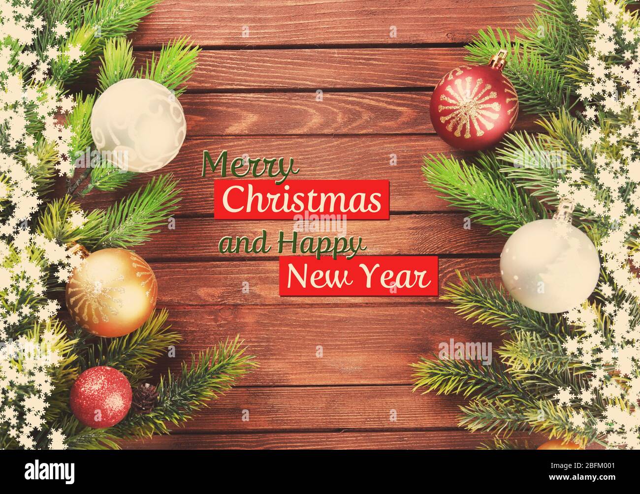 Christmas fir tree branches with toys on wooden table Stock Photo - Alamy