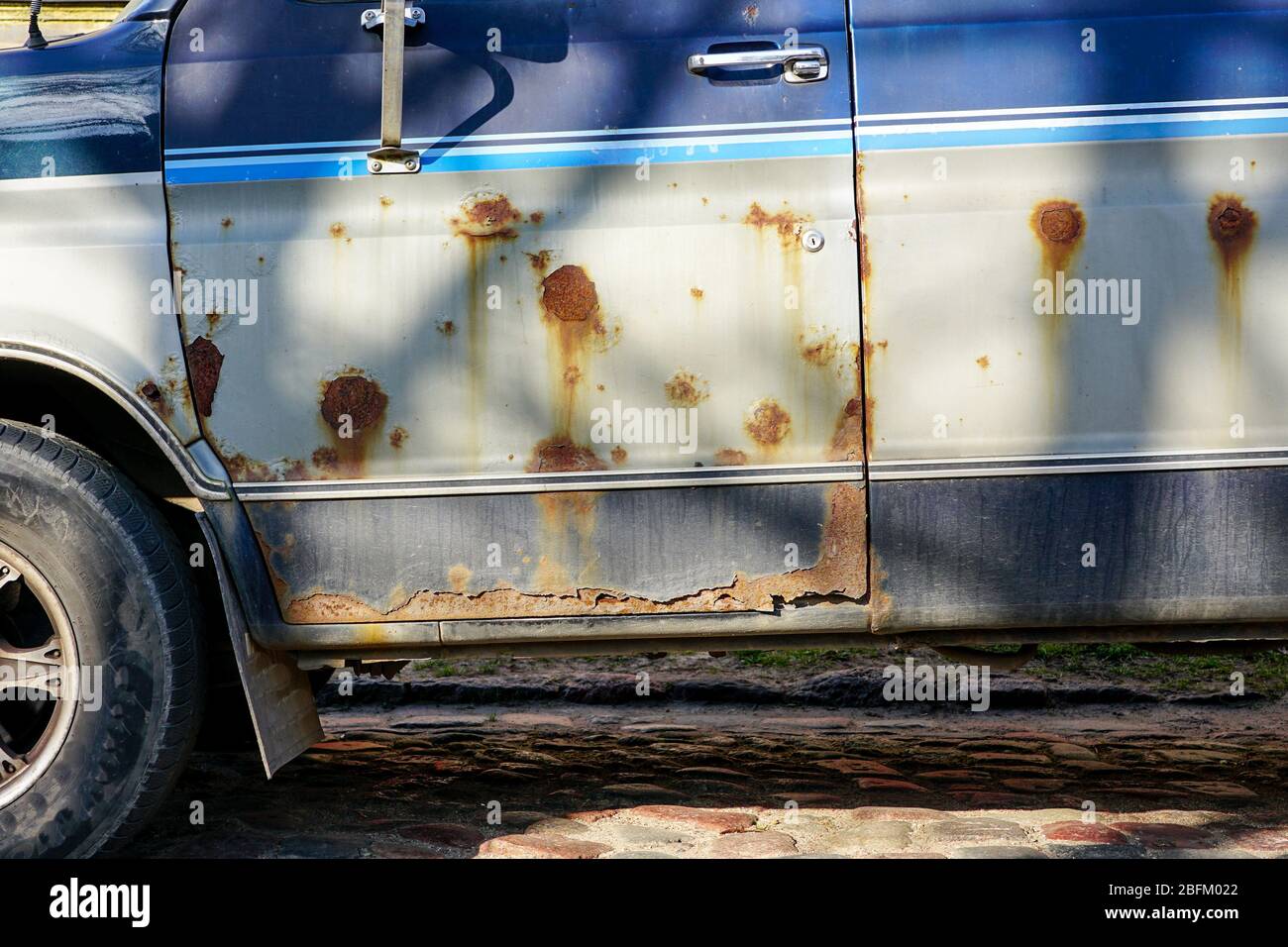 a fragment of a rusty car body on a city street Stock Photo - Alamy