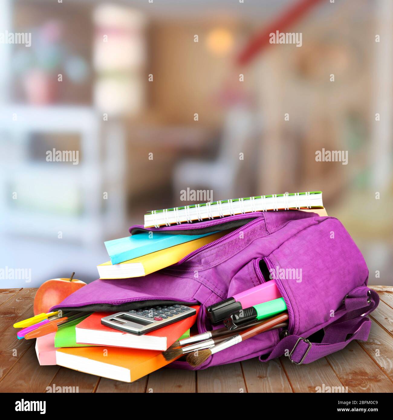 School backpack on wooden desk, on abstract background Stock Photo - Alamy