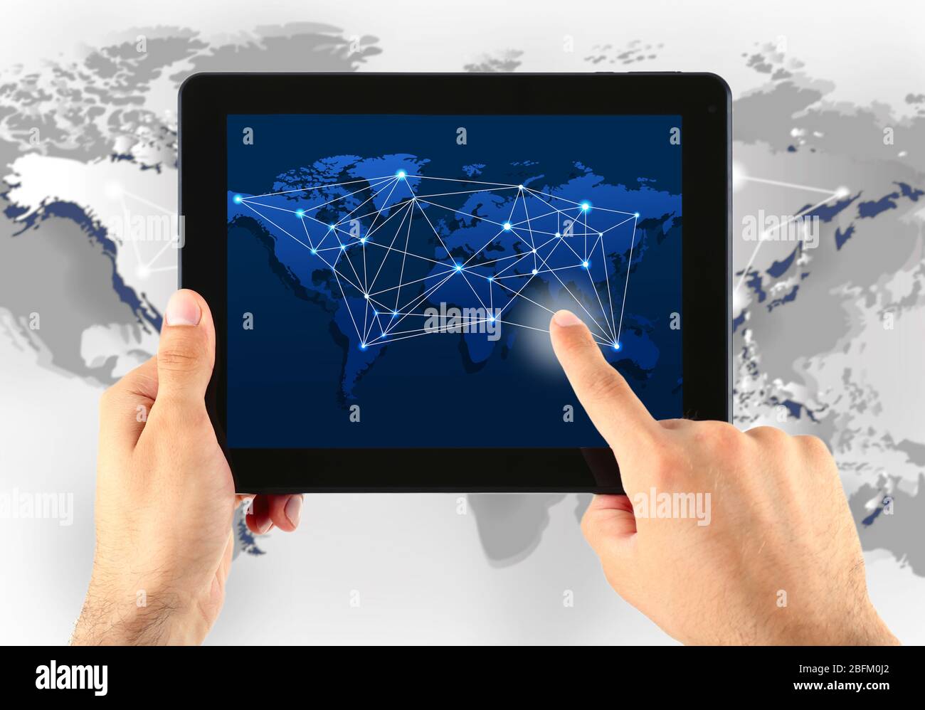 Close up of human hand touching screen of tablet pc with world map and ...