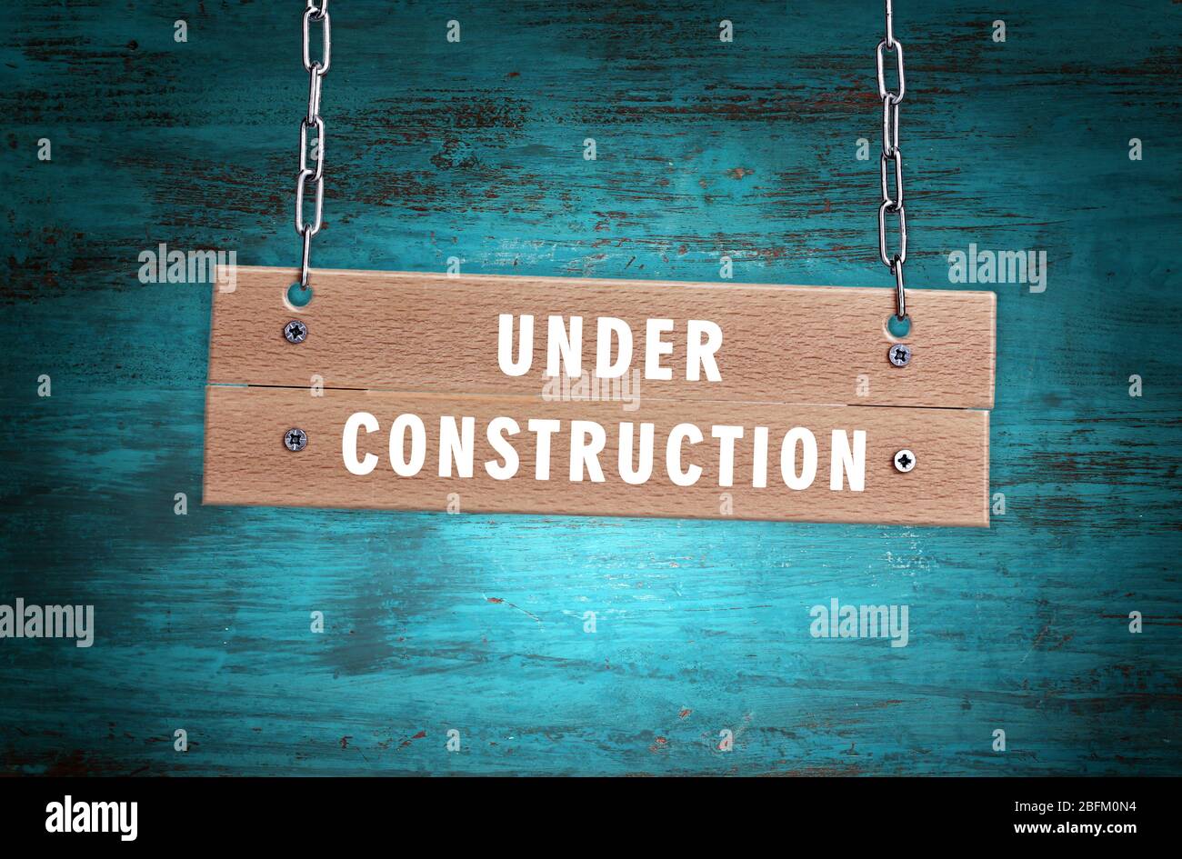 Wooden signboard with text Under Construction on wooden wall background ...
