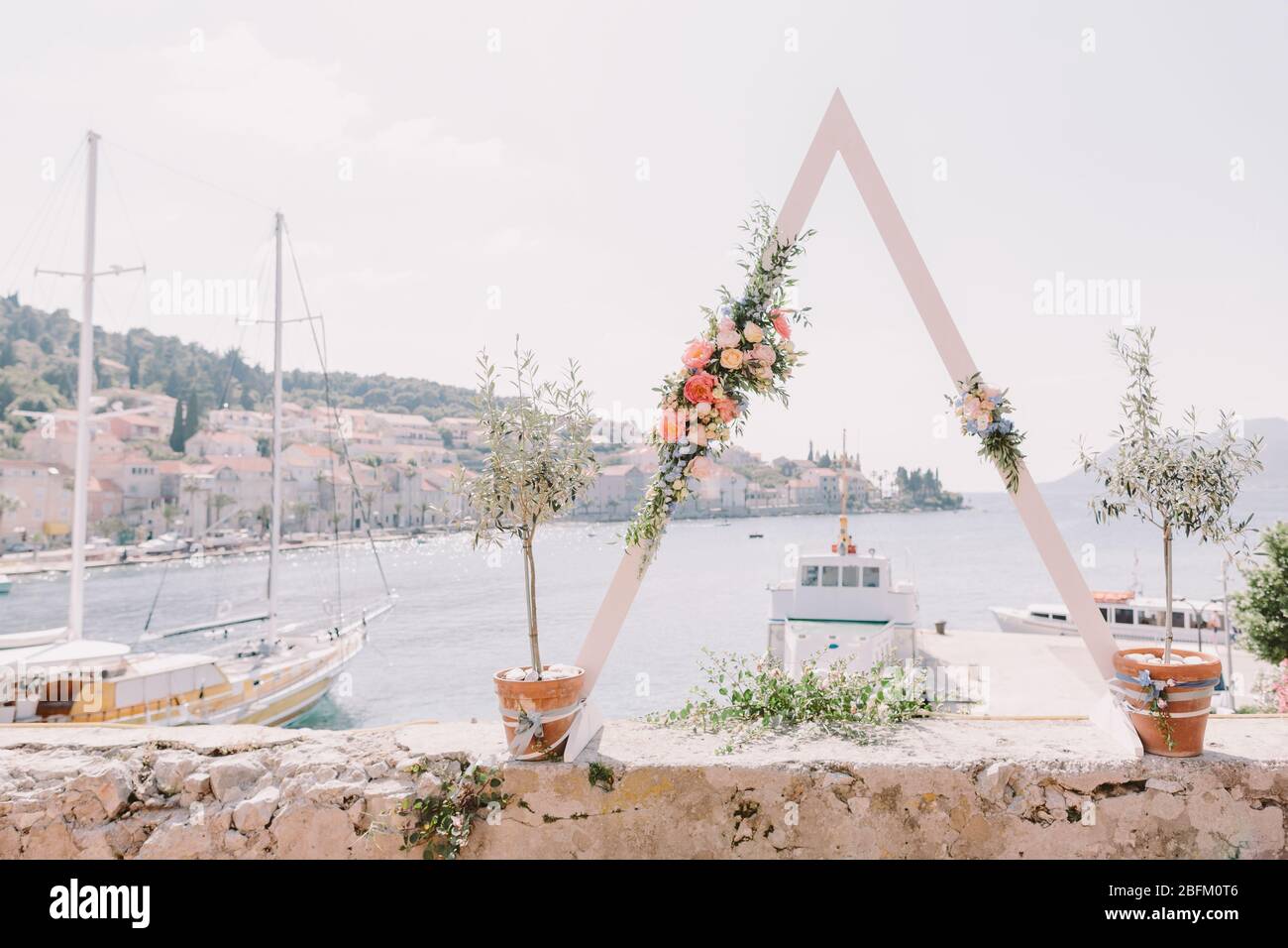 destination wedding arch with sea view. Triangle wedding arch in ...
