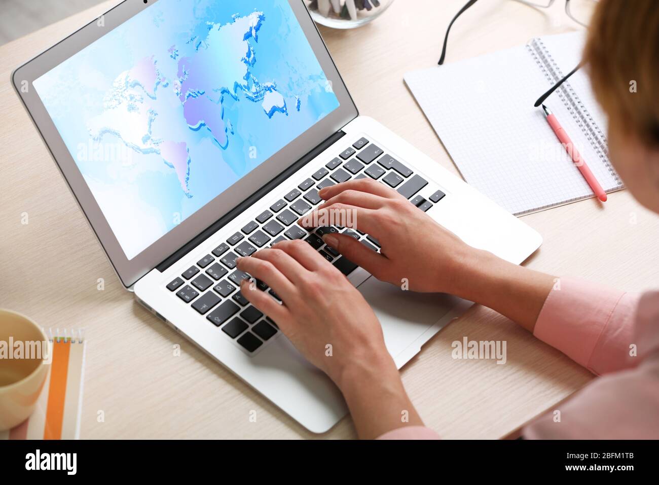 Human working with laptop, with world map and network on screen Stock ...