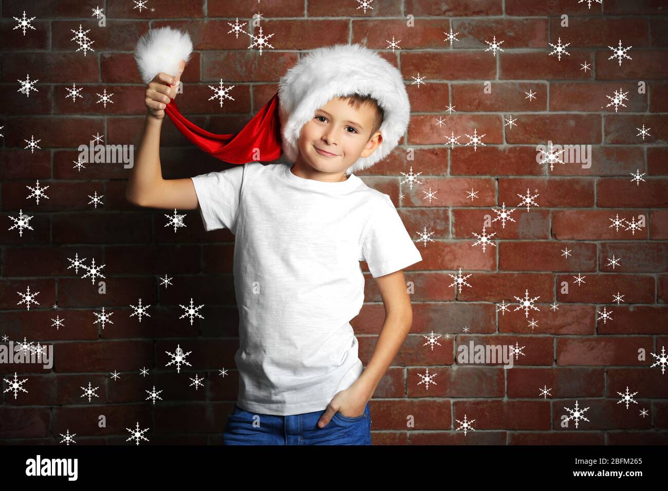 Cute little boy on brick wall background Stock Photo - Alamy
