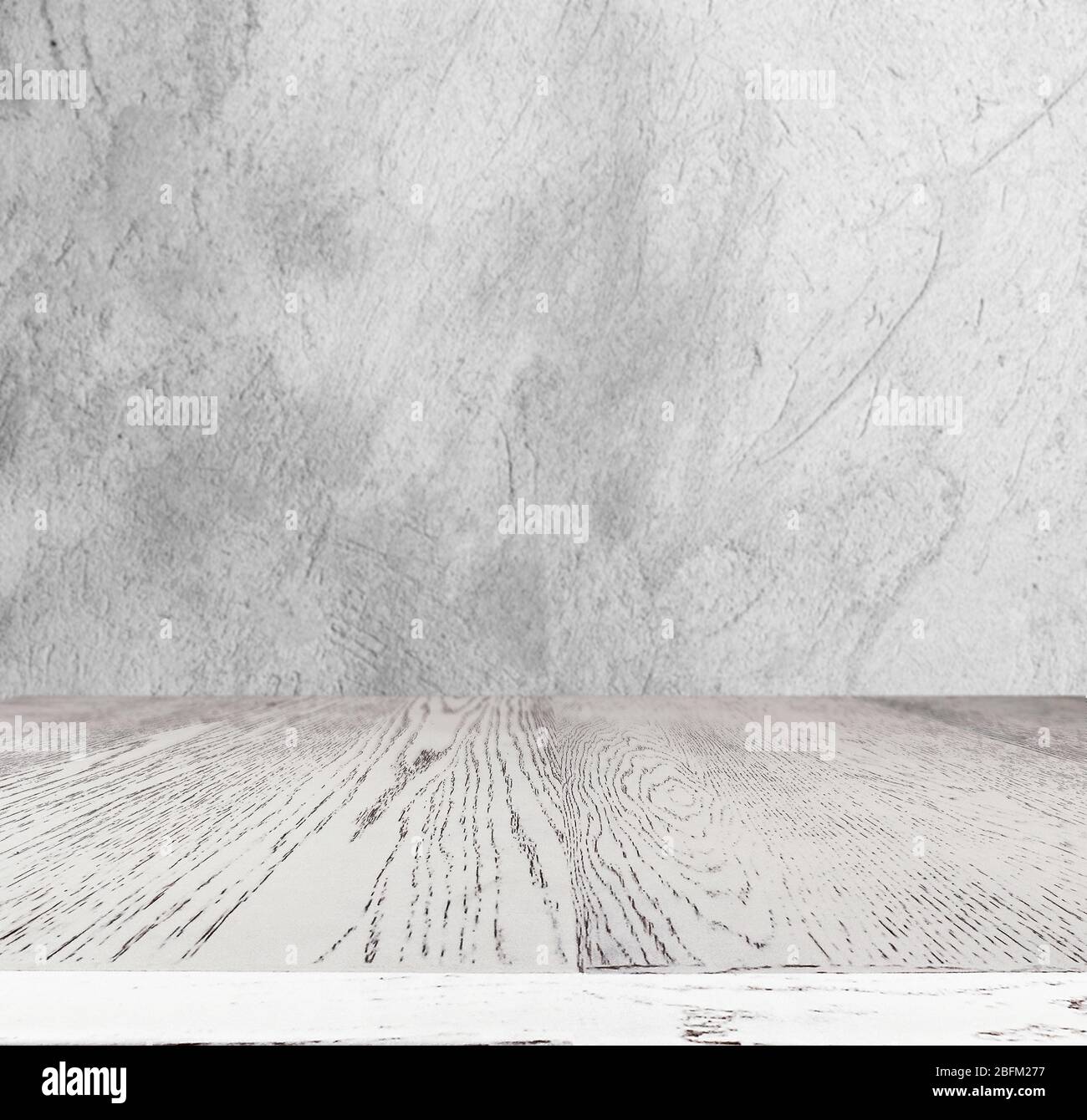 Wooden table on grey wall background Stock Photo - Alamy