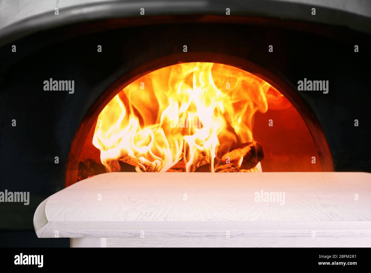 Wooden table on oven background Stock Photo - Alamy