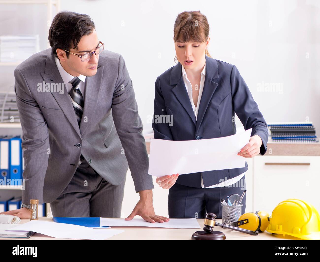 The man and woman discussing construction project Stock Photo - Alamy