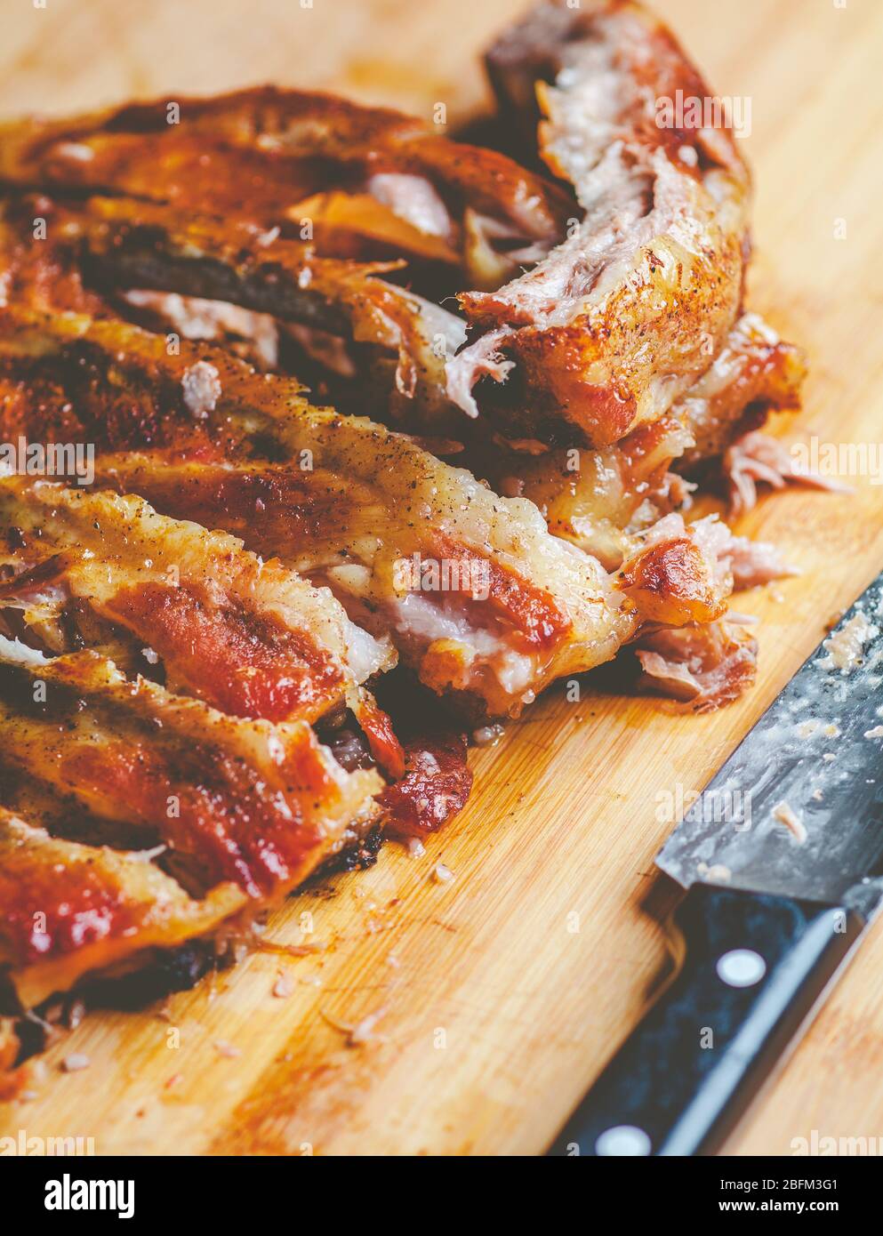 BBQ spare pork ribs. Hot and spicy grill on a wooden set and knife cut ...