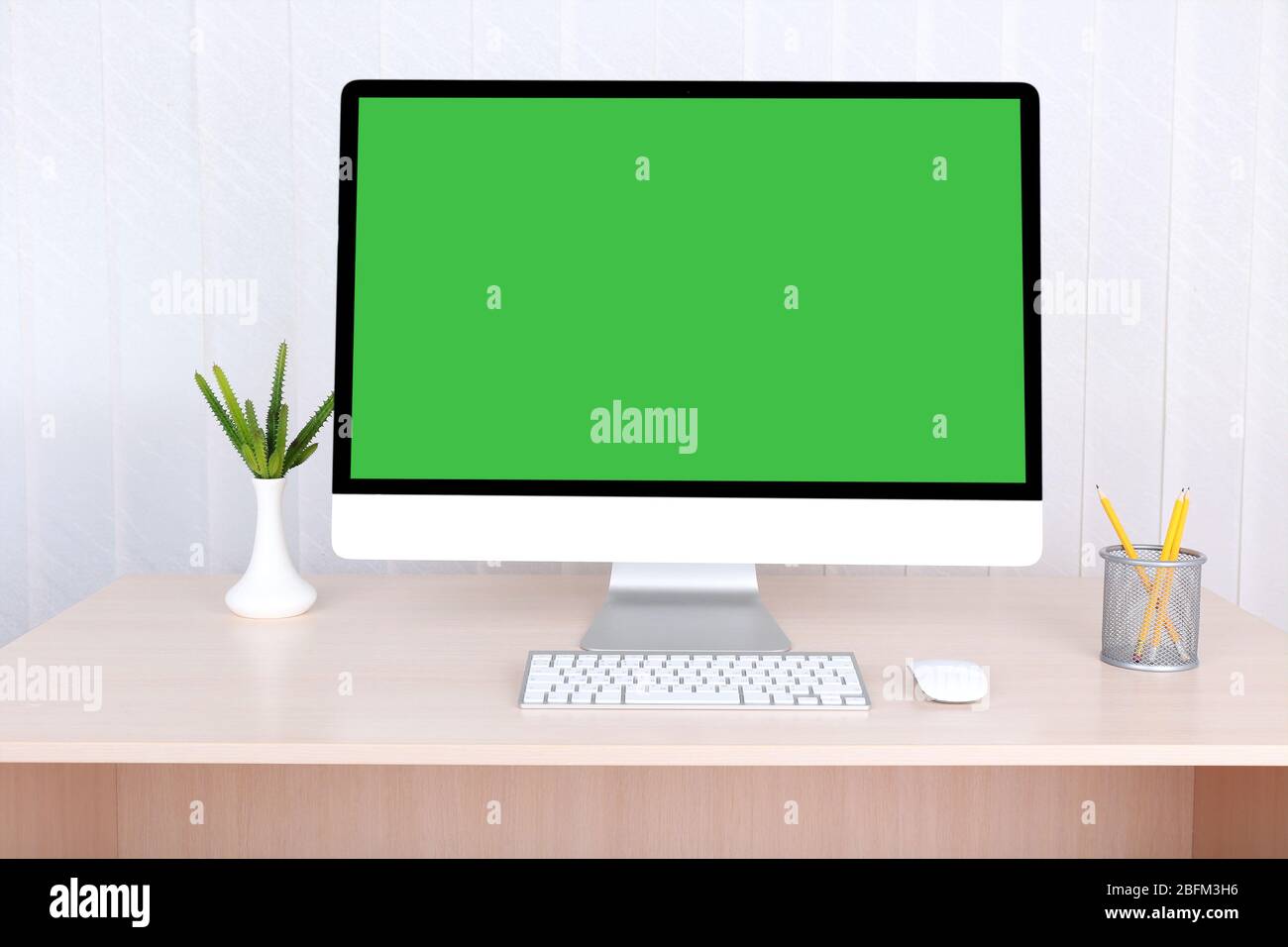 Modern computer with green screen, on table Stock Photo - Alamy