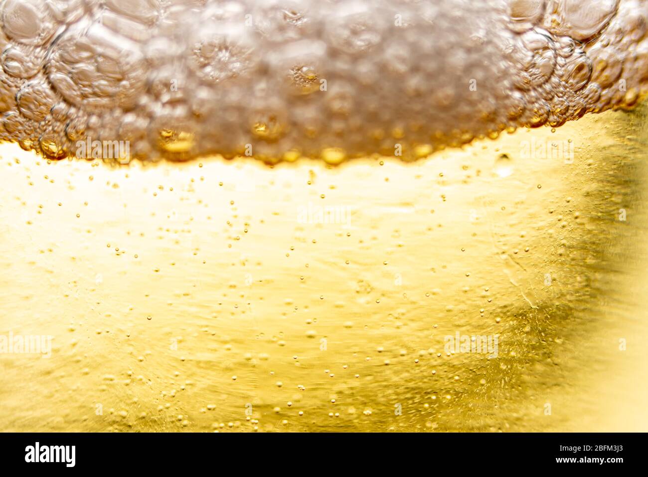Texture of foam and bubbles in light beer. Abstract background for ...