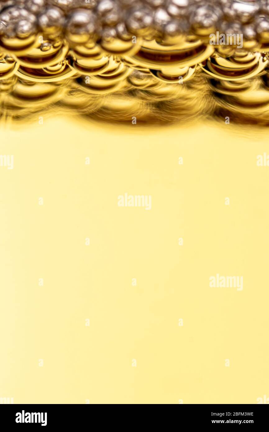 Texture of foam and bubbles in light beer. Abstract background for ...
