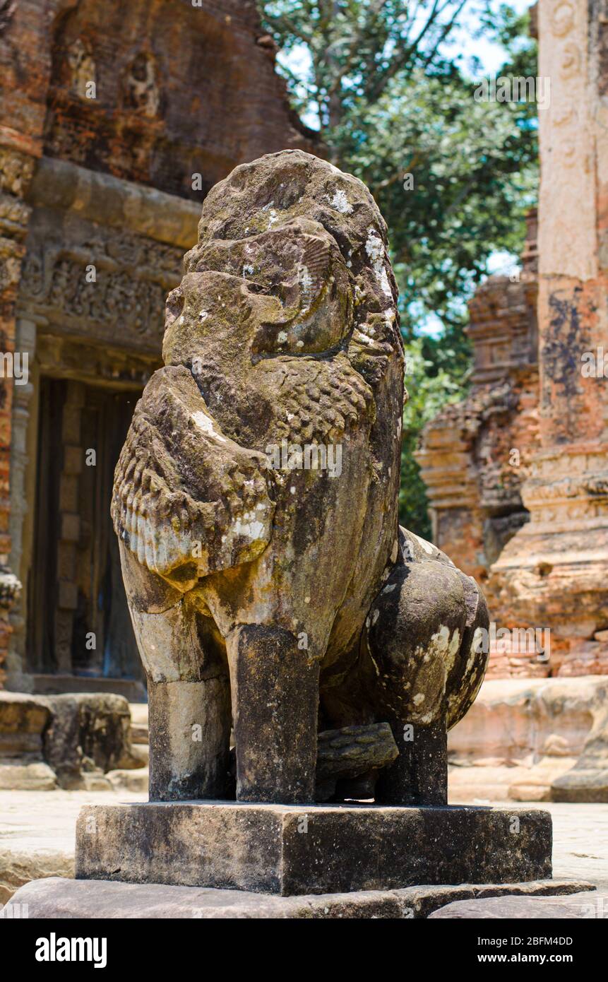 Ruined lion sculpture guarding the ancient hindu temple of Preah Ko in Angkor Wat Unesco ...