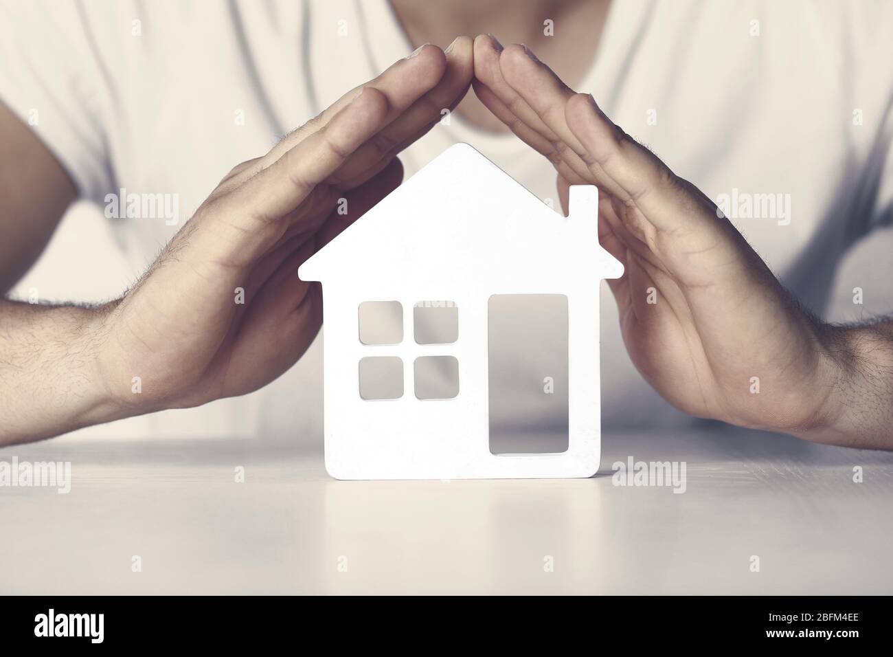 Male hands and house, closeup Stock Photo - Alamy