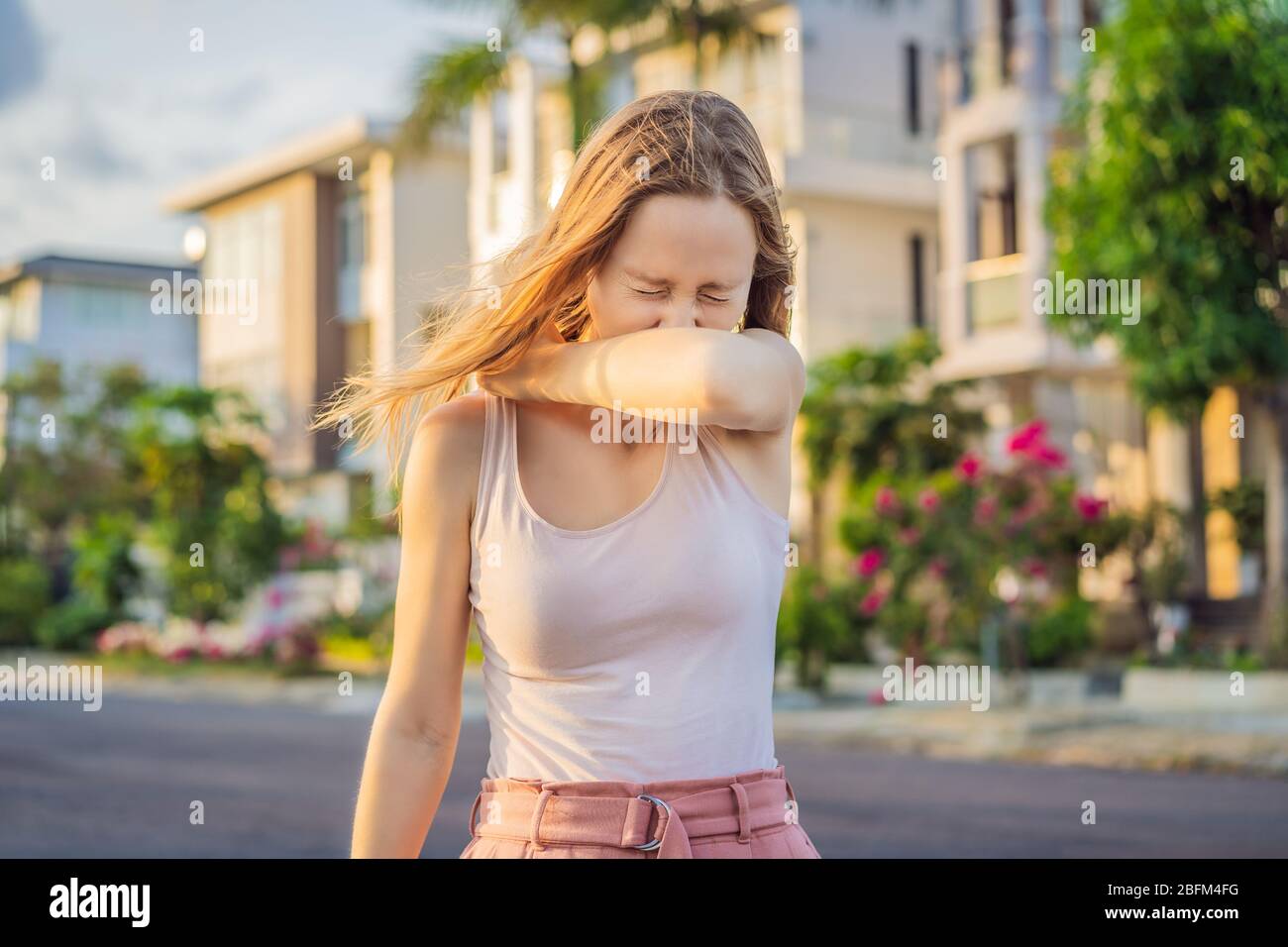How to sneeze correctly. Woman sneezes on the elbow. Concept of the ...