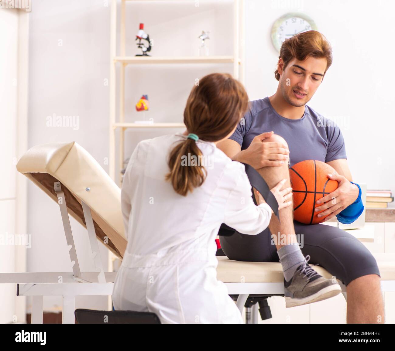 The handsome basketball player visiting female doctor traumatologist ...
