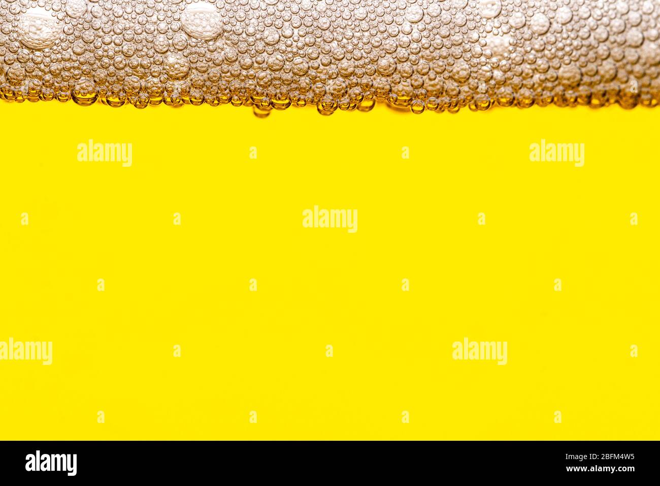 Texture of foam and bubbles in light beer. Abstract background for ...