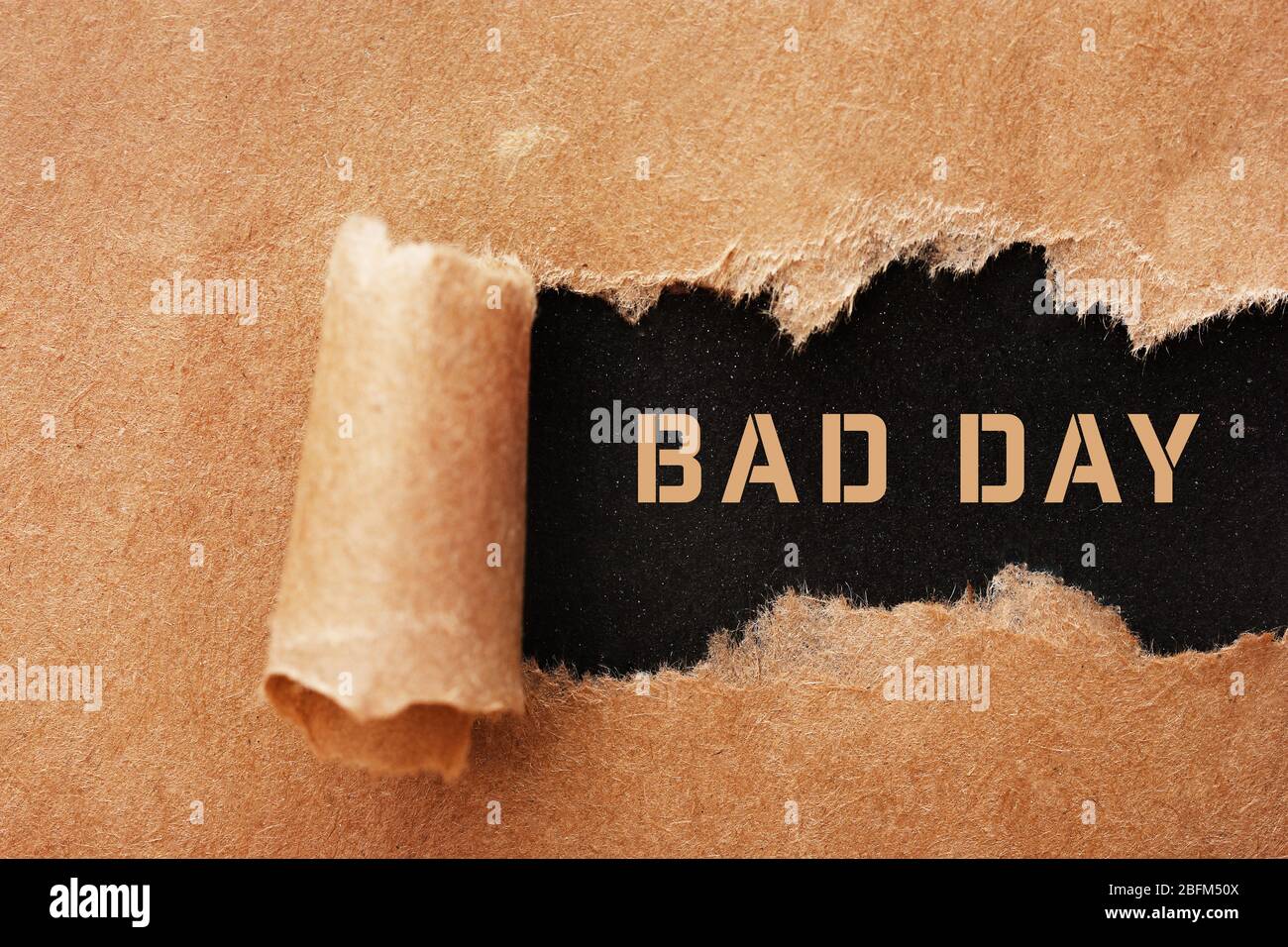 Torn black paper with red background and text Bad day Stock Photo - Alamy