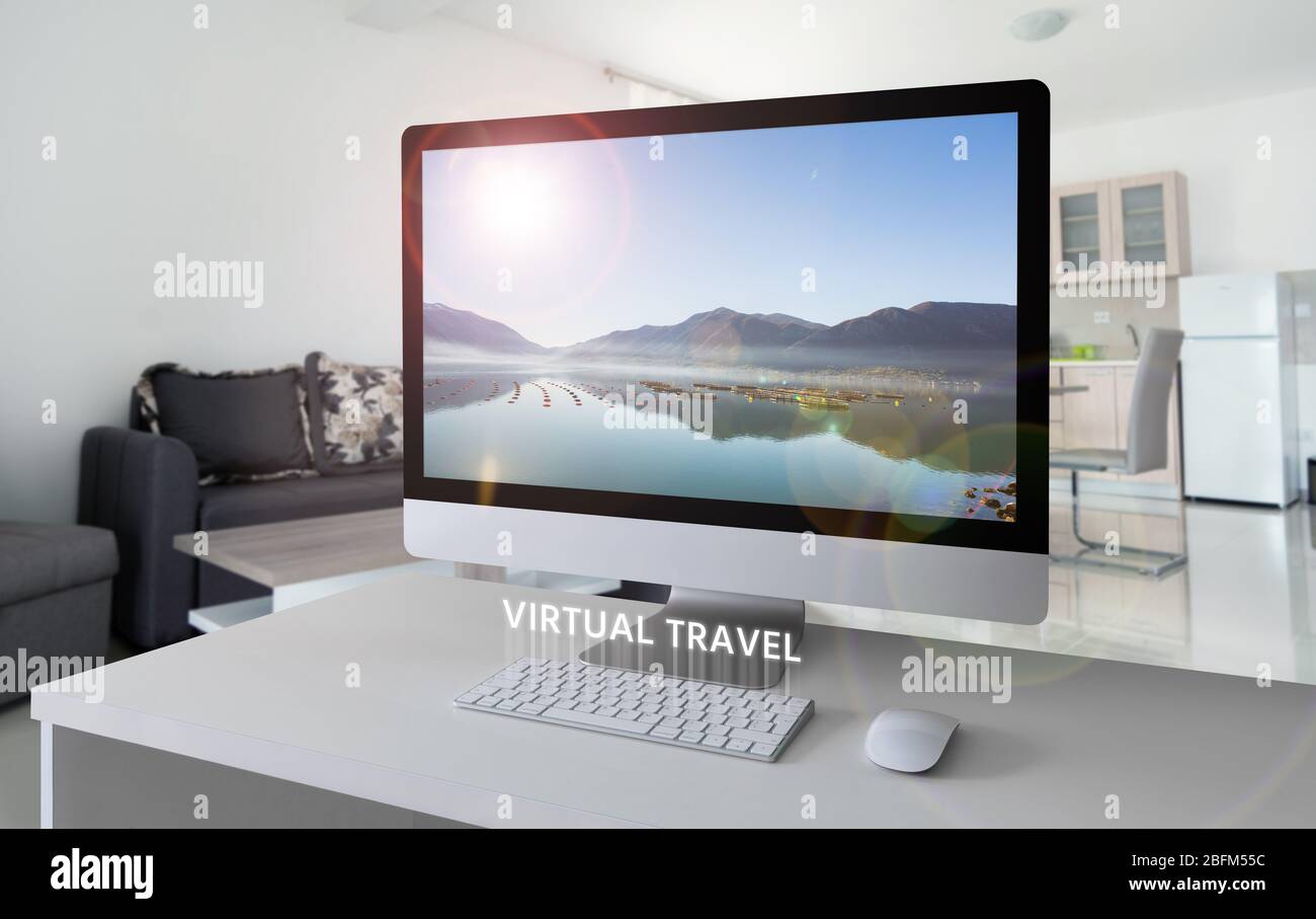 Computer with a view of the bay in the mountains on the screen. Virtual ...