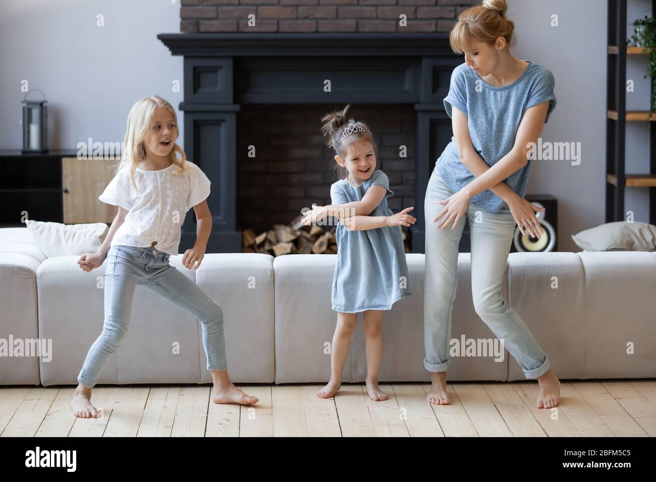 Happy mother dancing, having fun with two daughter Stock Photo - Alamy