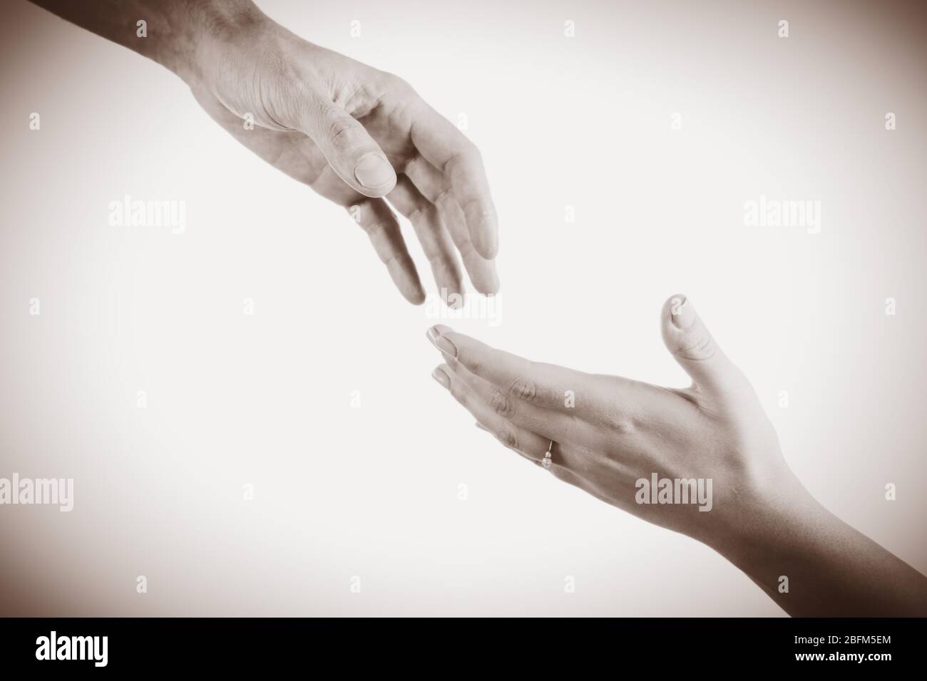 Two hands reaching toward each other. Helping concept. Vintage tone ...