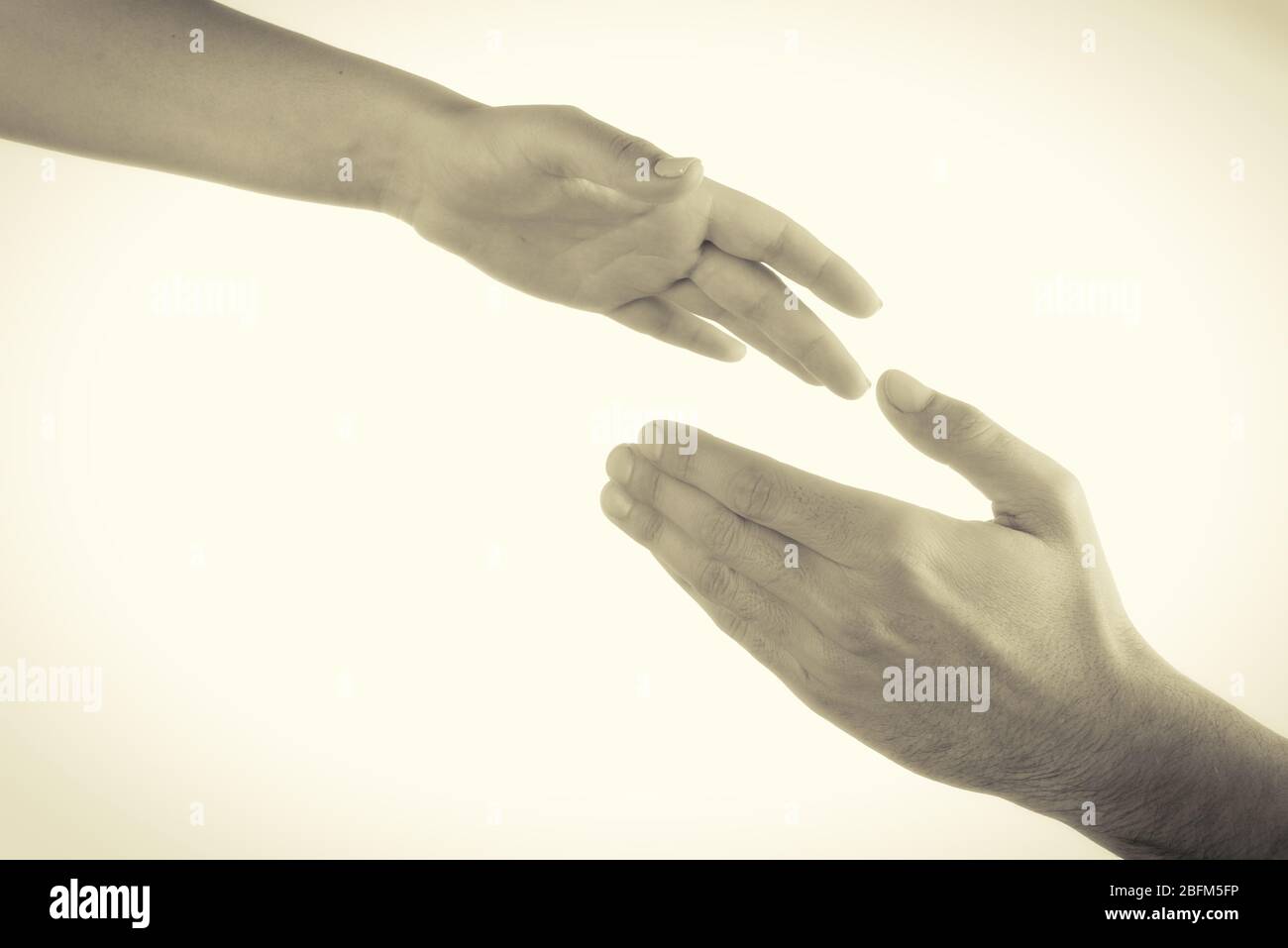 Two hands reaching toward each other. Helping concept. Vintage tone ...