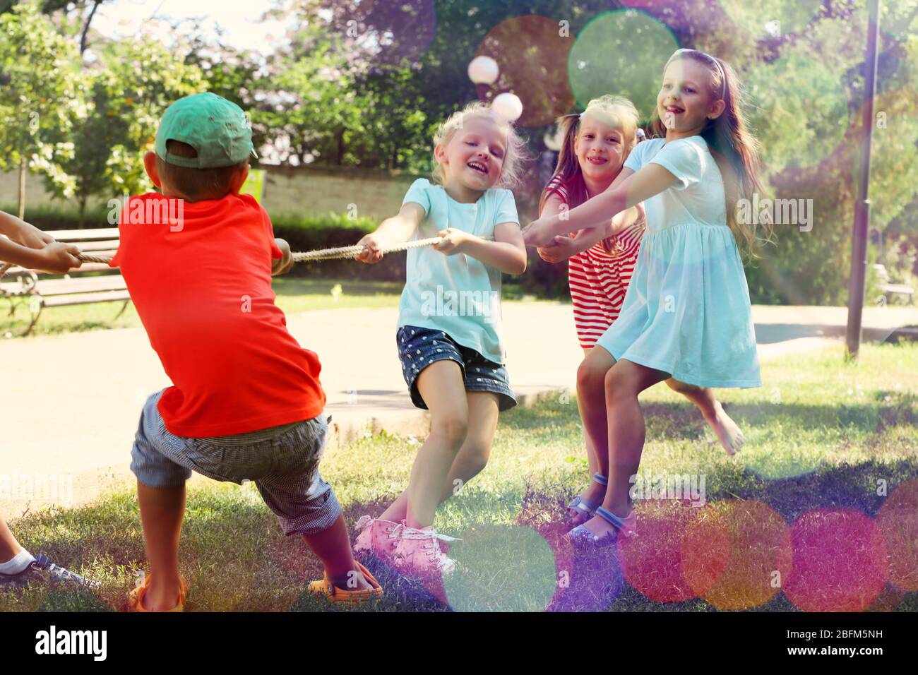 Happy active children playing in park Stock Photo - Alamy