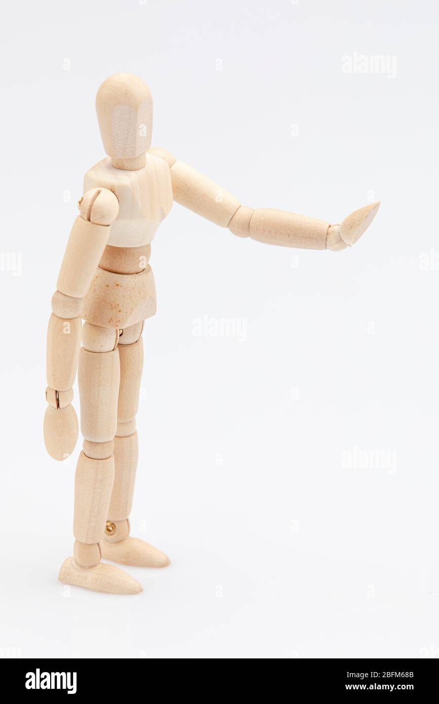 Wooden dummy refusing something to someone in front of a white ...