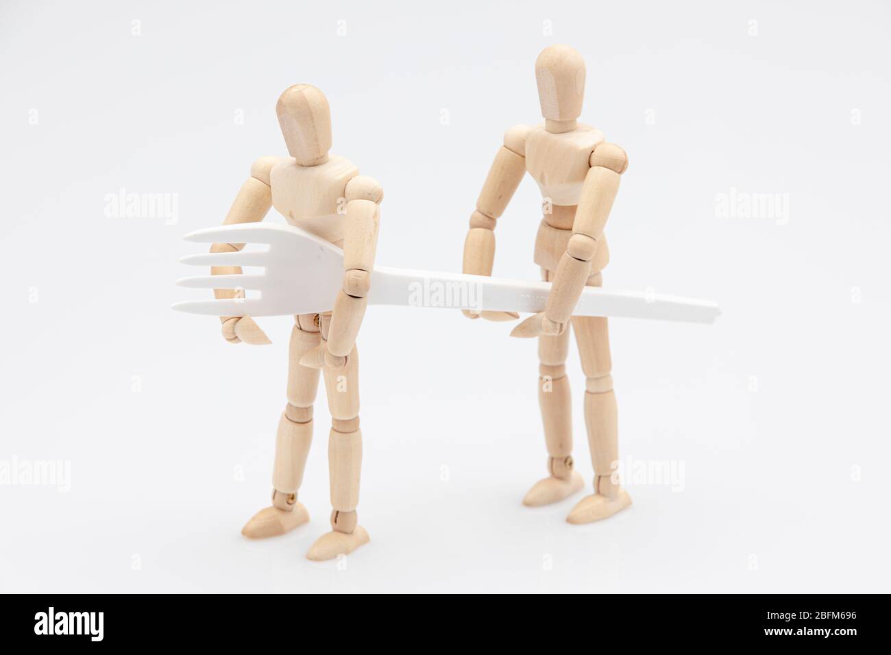 Wooden dummies carrying a biodegradable fork in front of a white ...